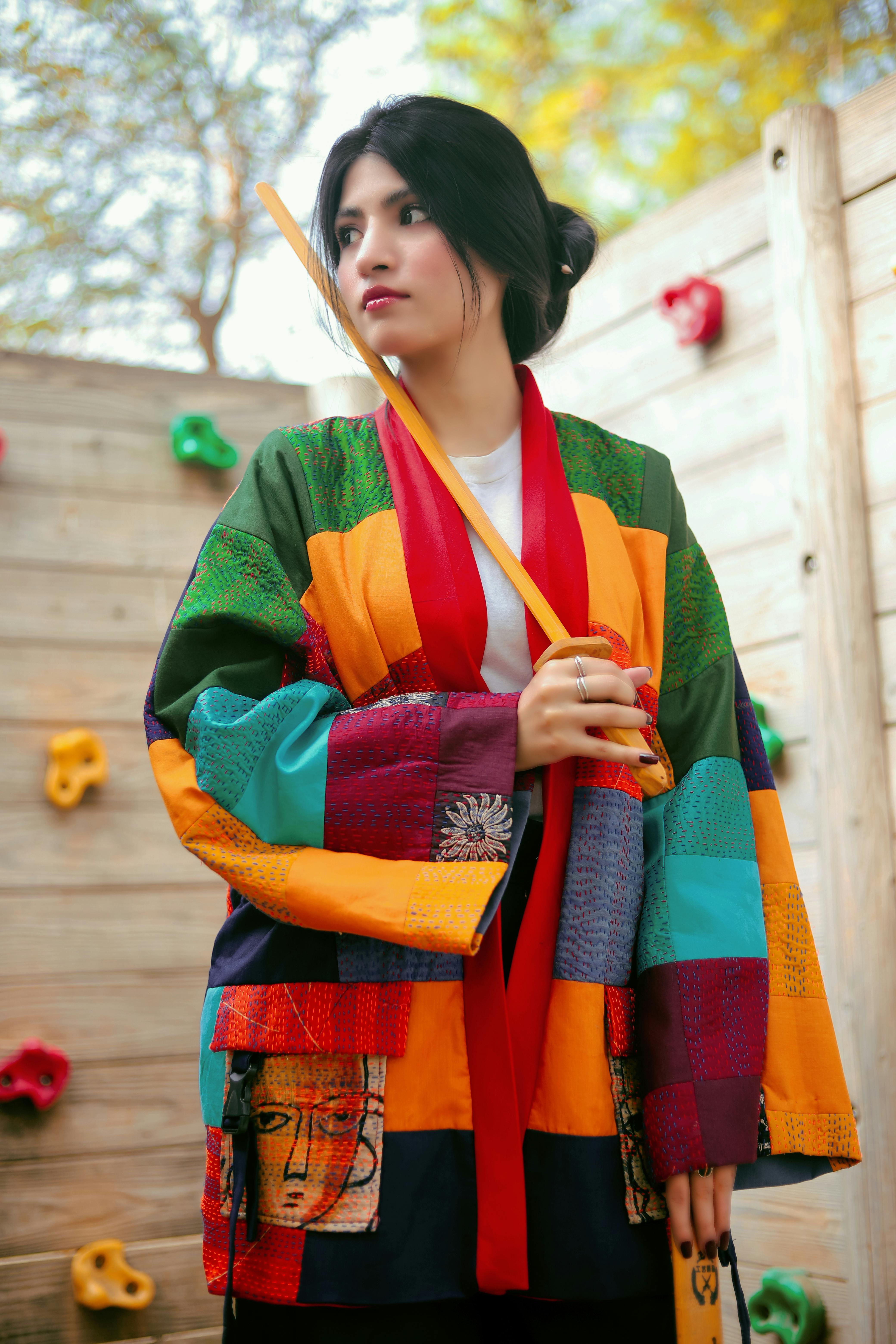Portrait of a Stylish Woman in Colorful Japanese Style Jacket Holding a ...