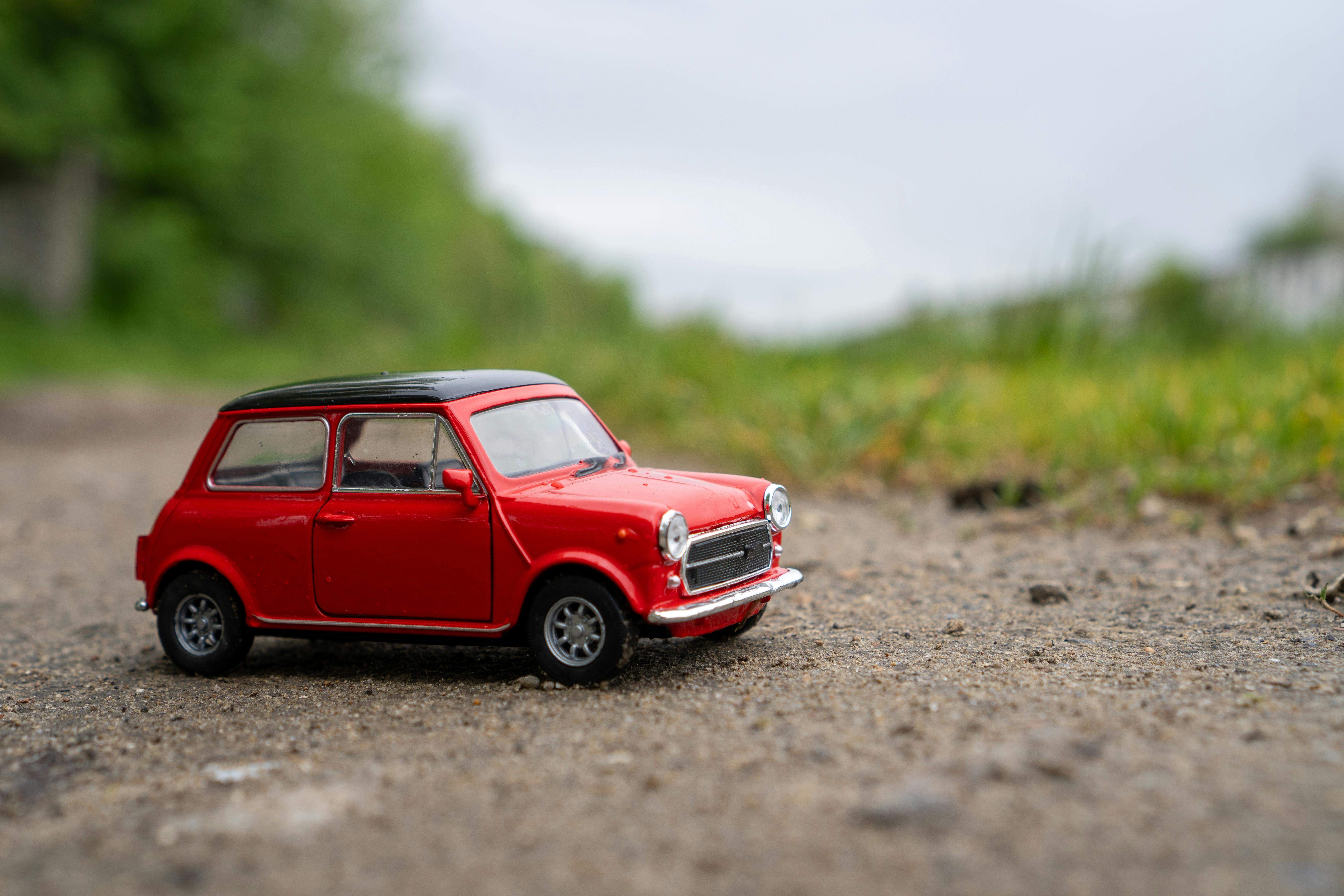 Green Scale Model Car on Brown Pavement · Free Stock Photo