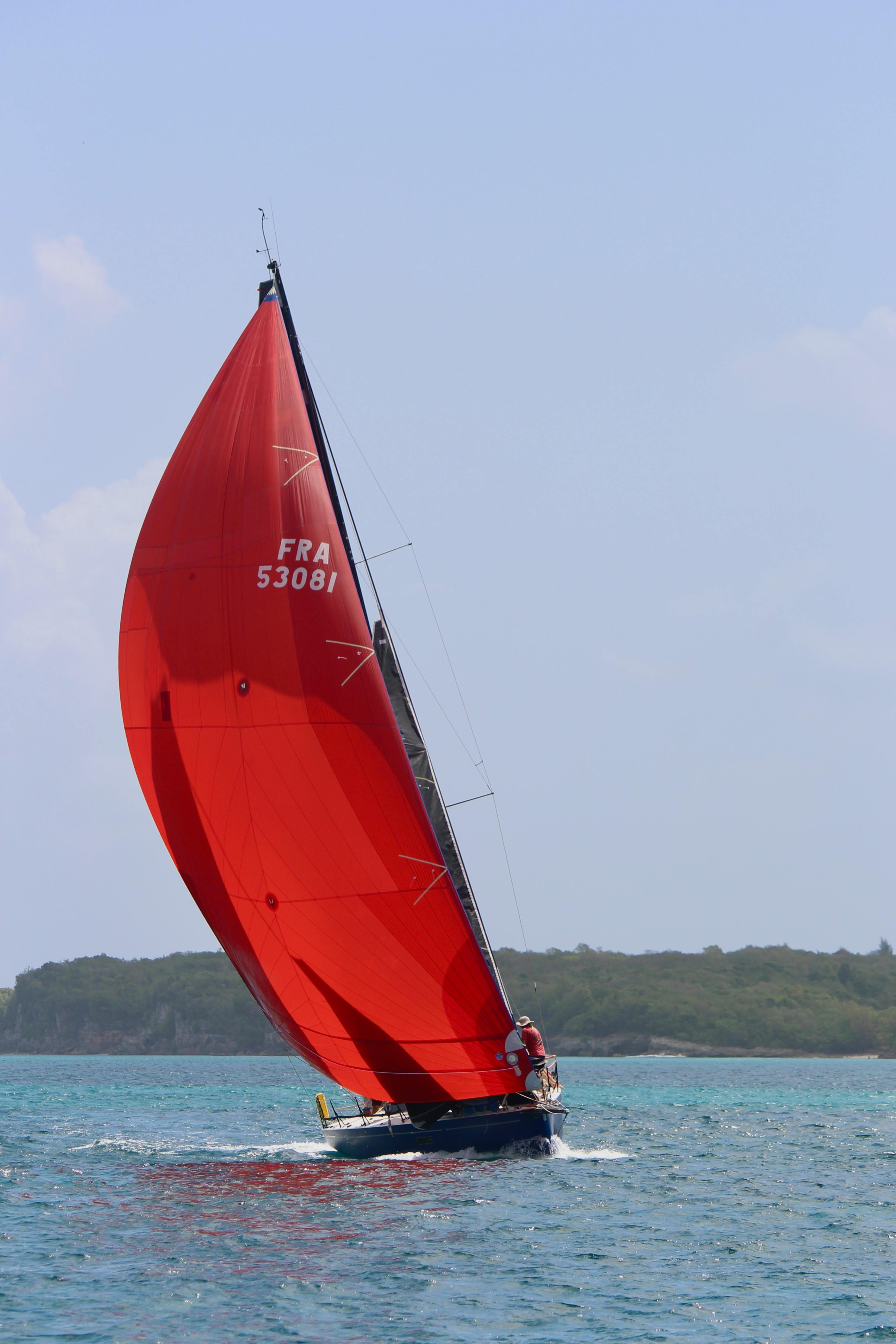 Yacht with a Red Sail at the Sea · Free Stock Photo