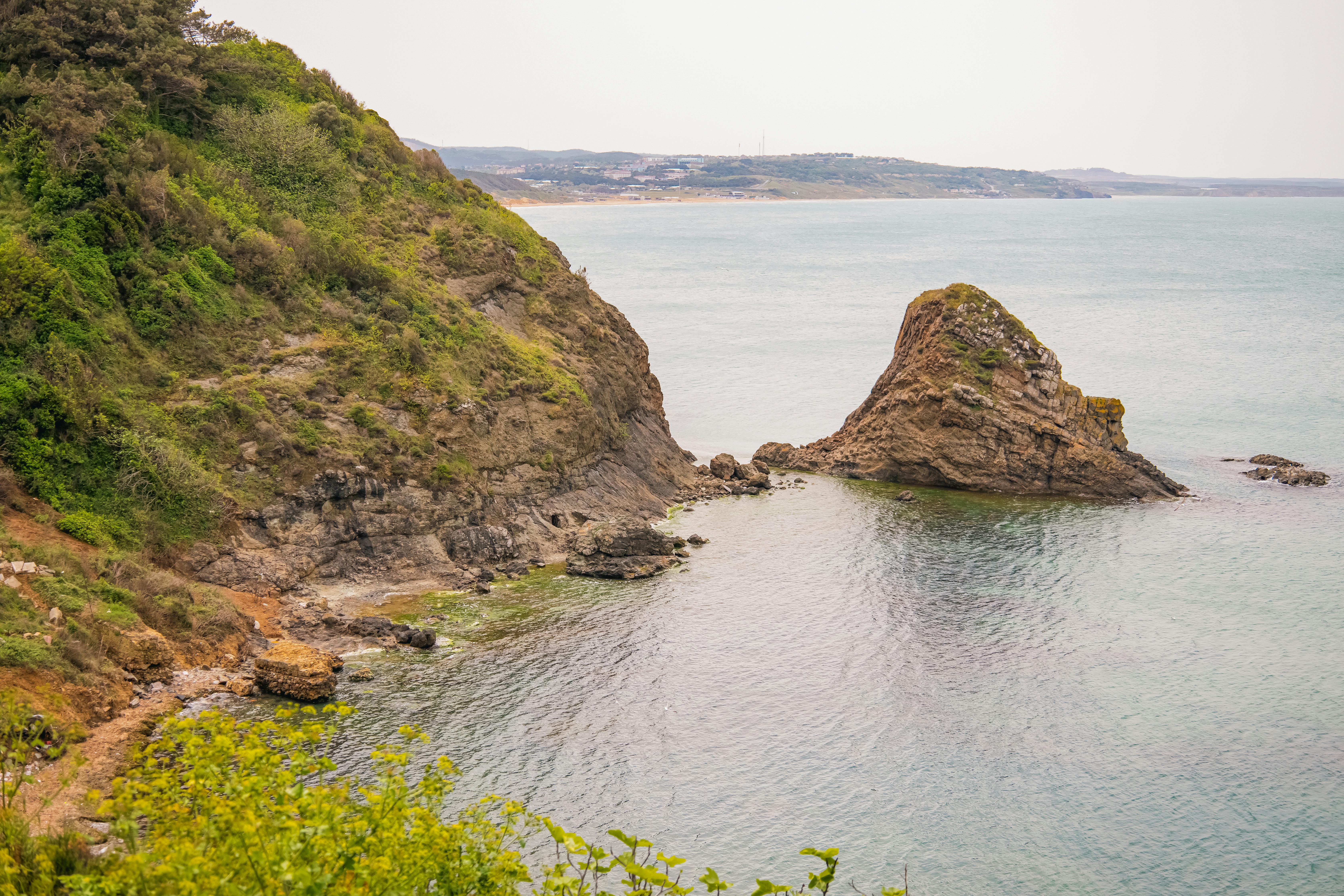 Triangular Rock by the Seaside Cliff · Free Stock Photo