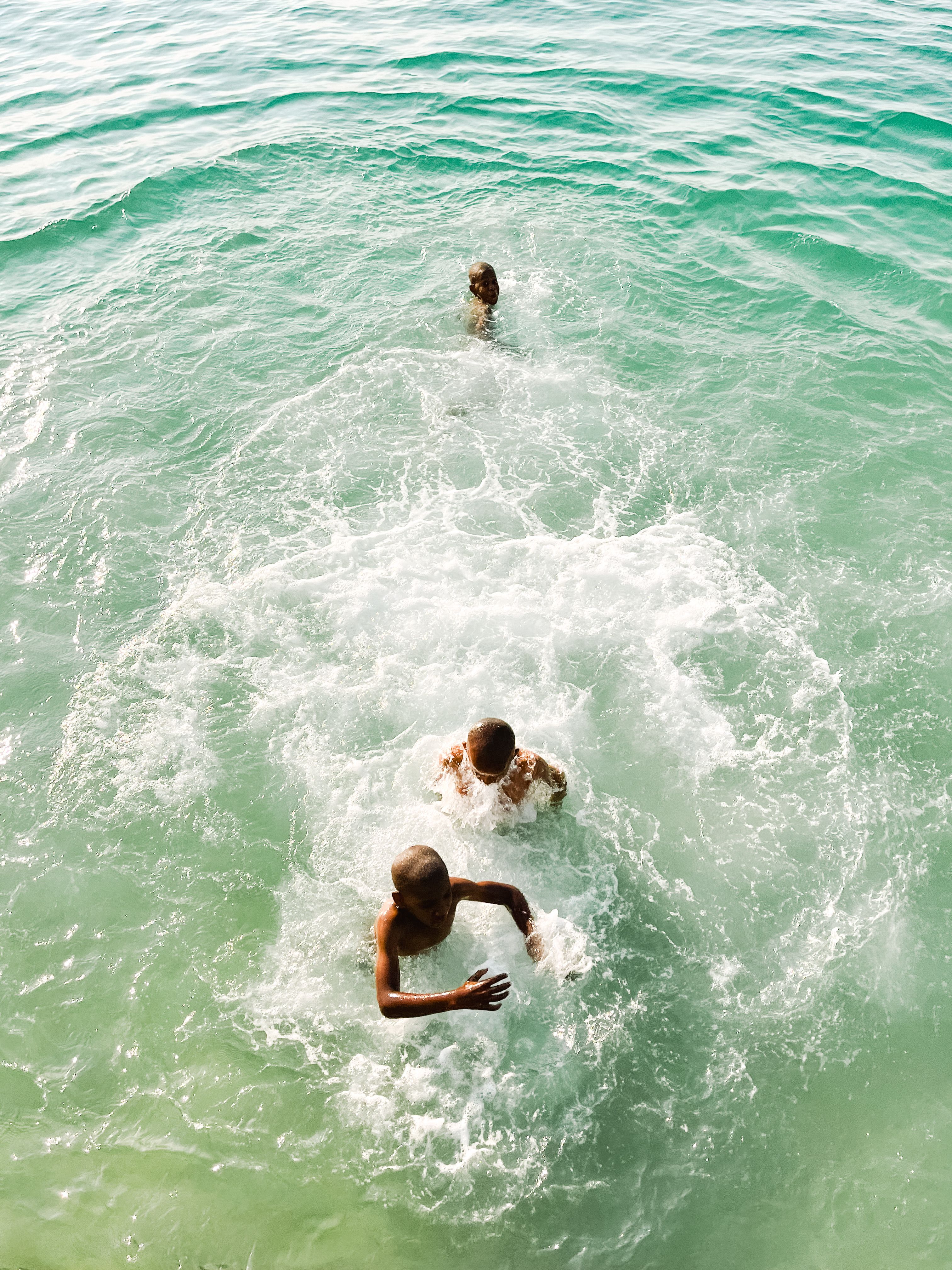 Boys Swimming on Sea Shore · Free Stock Photo