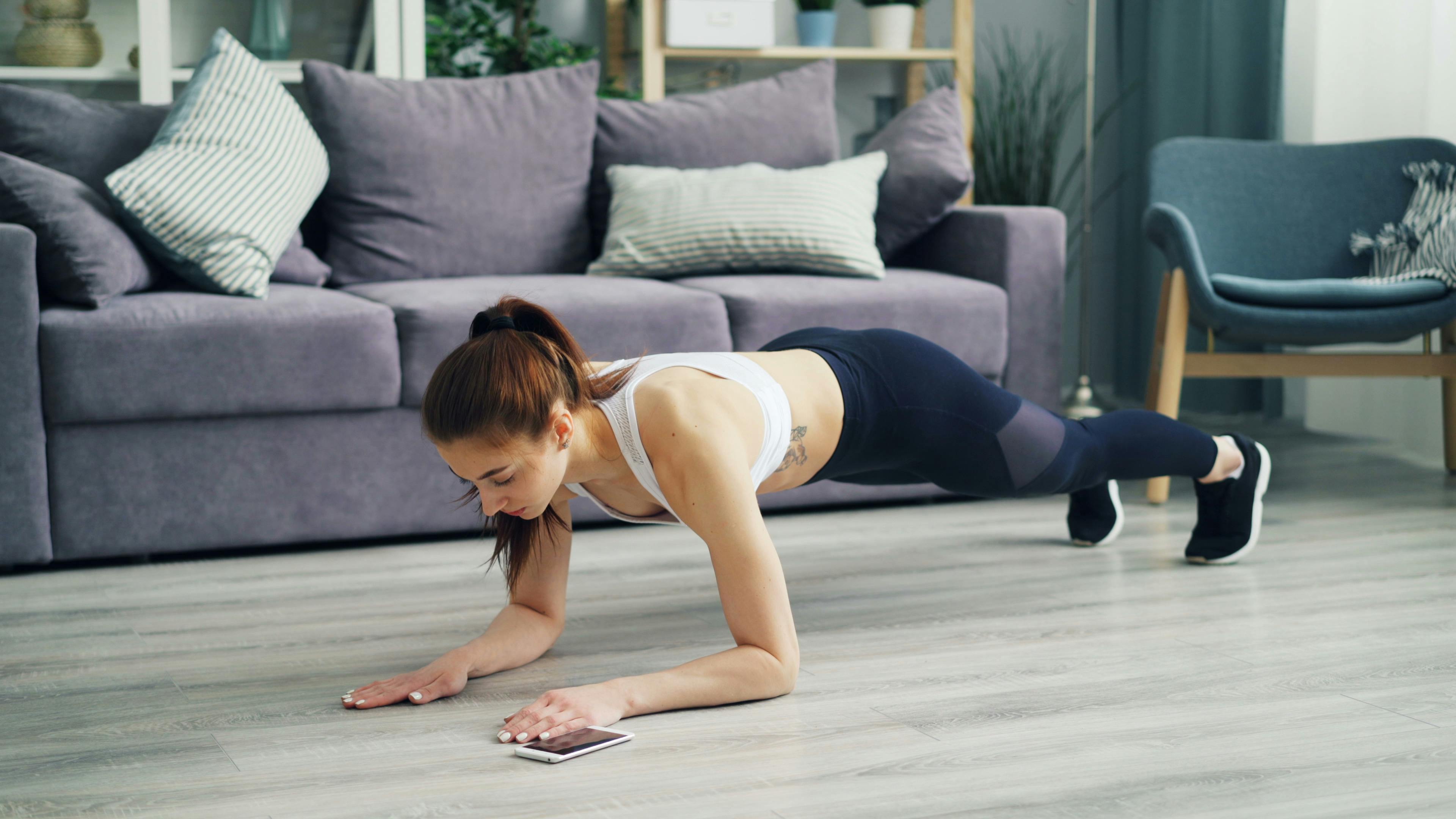 Woman Exercising Plank on Floor · Free Stock Photo