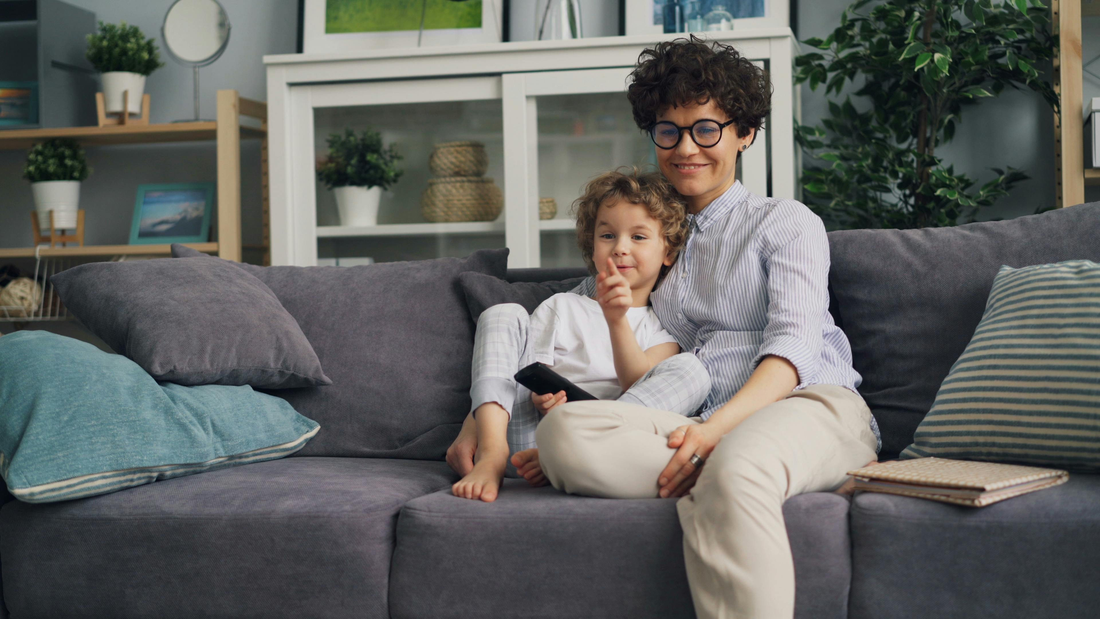 Smiling Mother and Son Sitting on Couch · Free Stock Photo