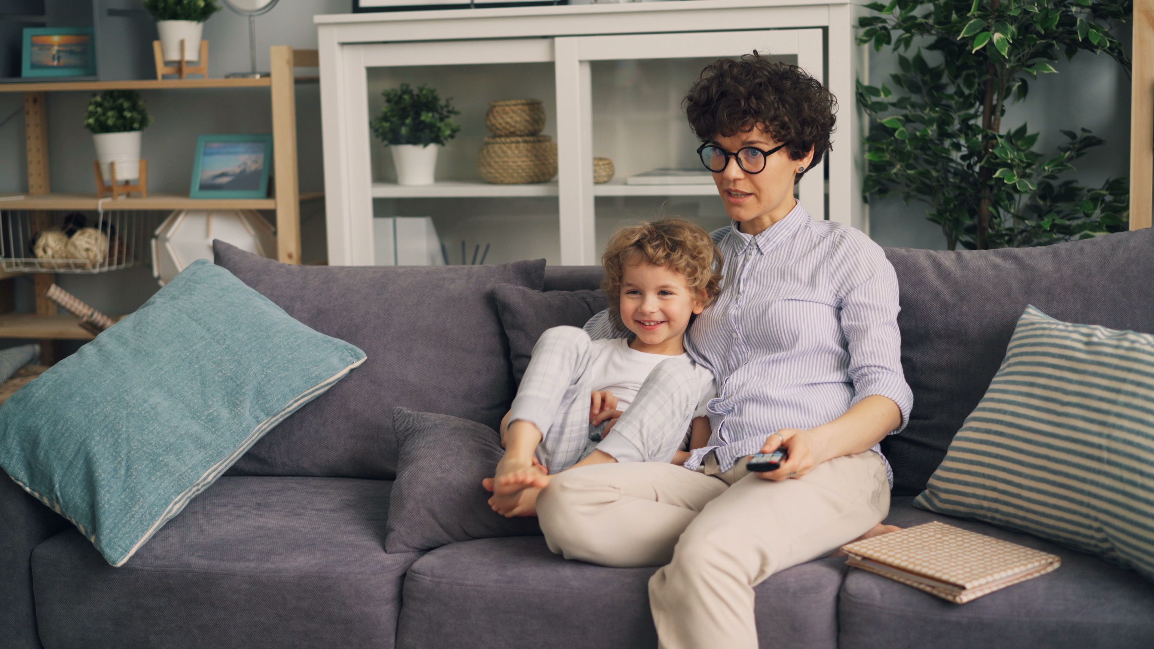 A Woman with a Child Watching TV · Free Stock Photo