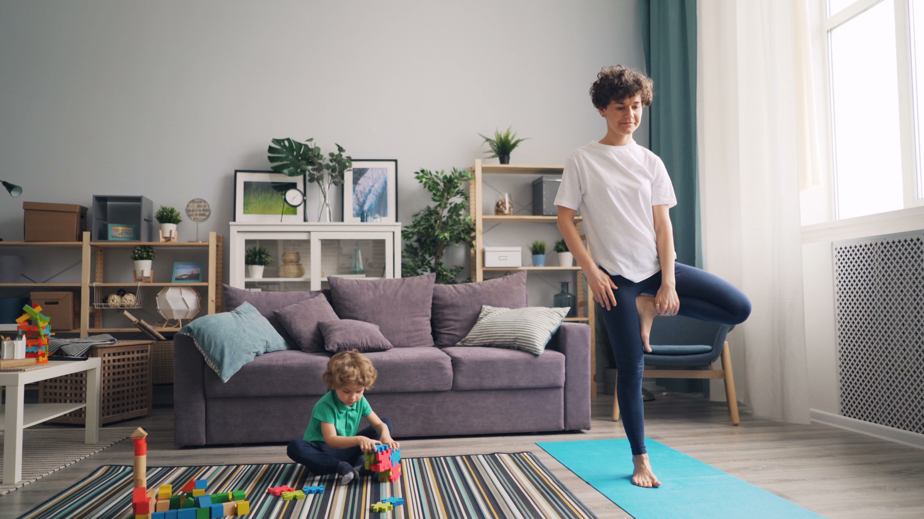 A Woman Exercising on a Mat and a Boy Playing with Blocks · Free Stock ...