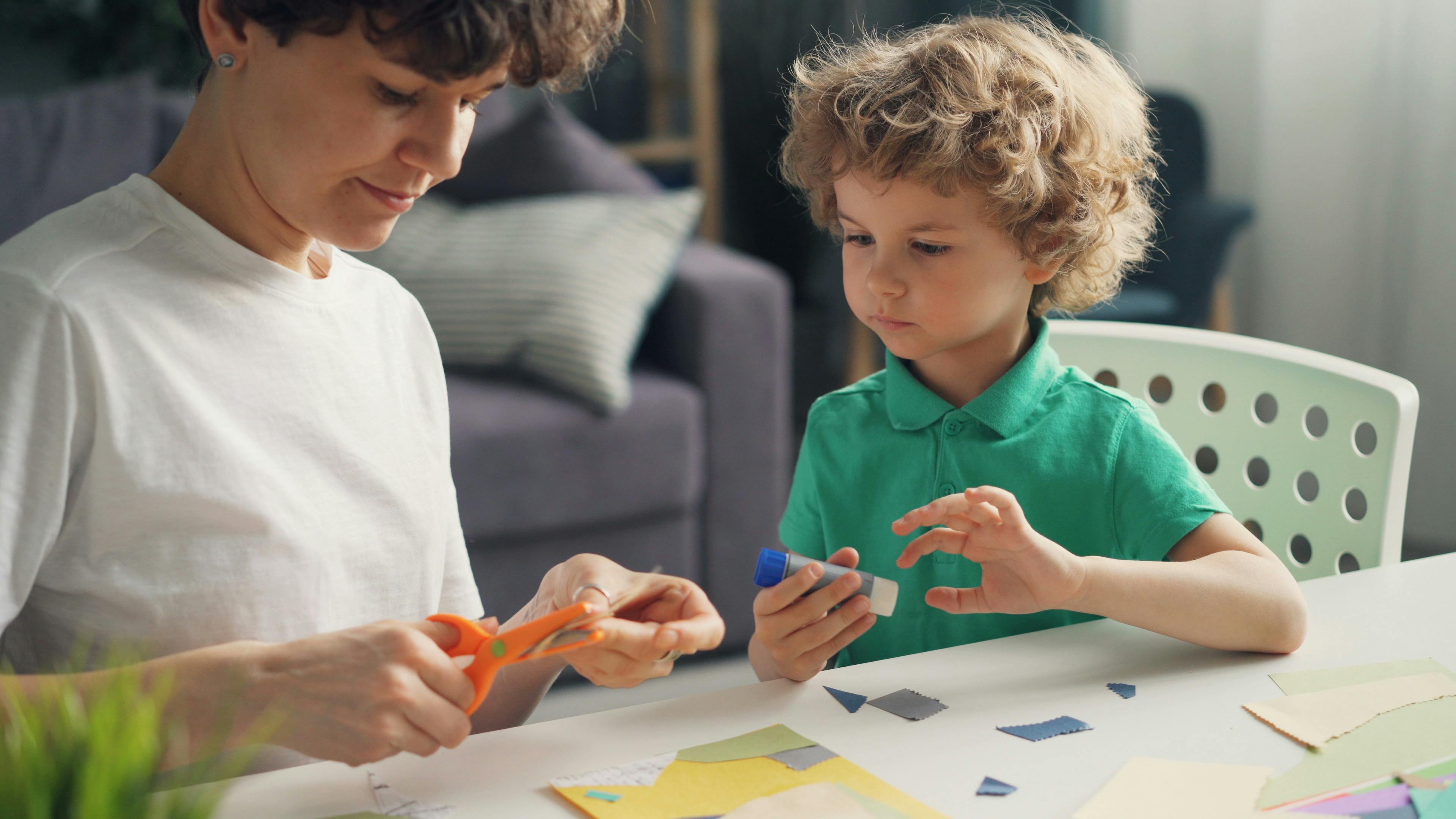 Two children playing with paper and scissors · Free Stock Photo