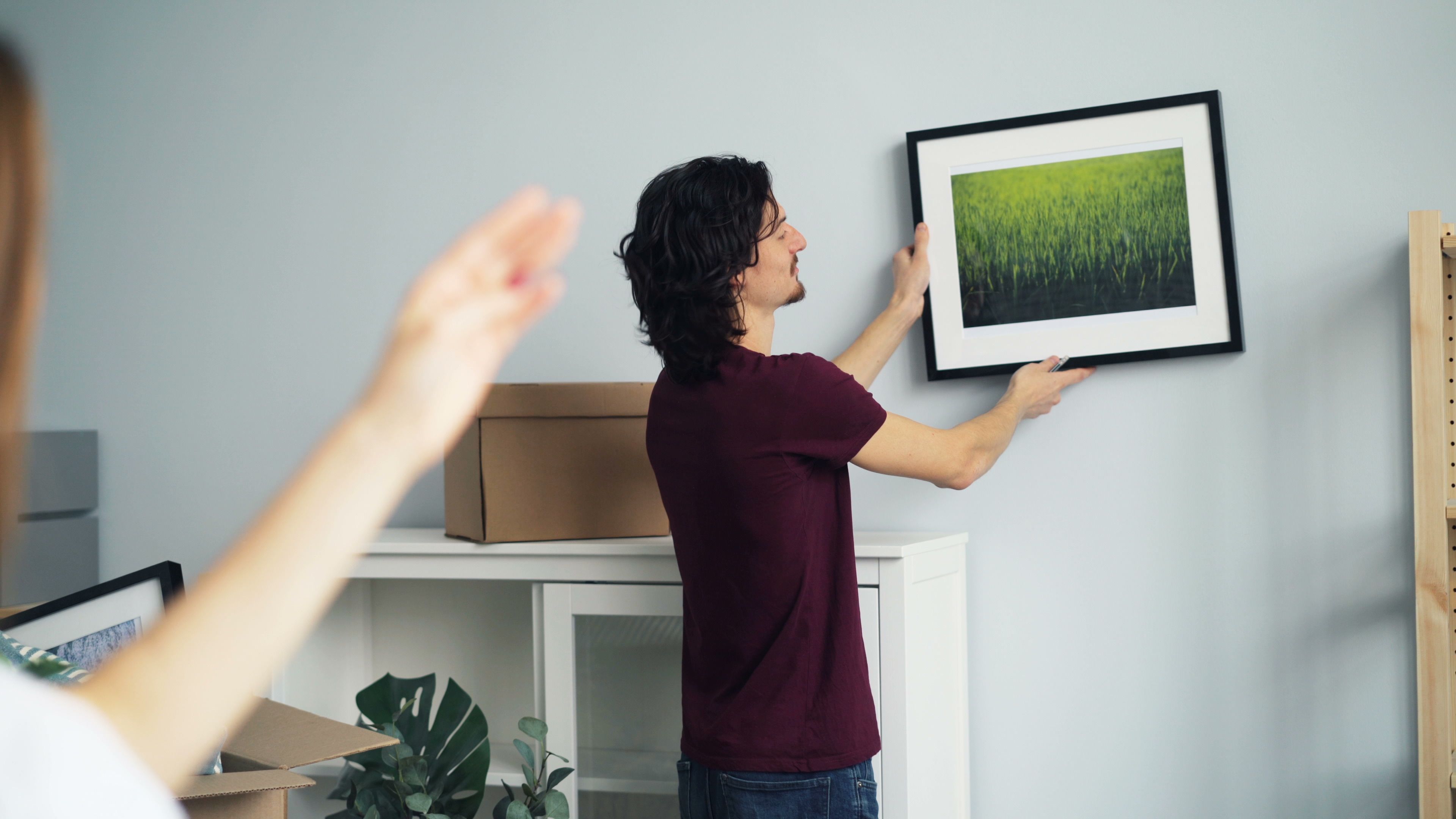 Man Putting Picture on Wall · Free Stock Photo