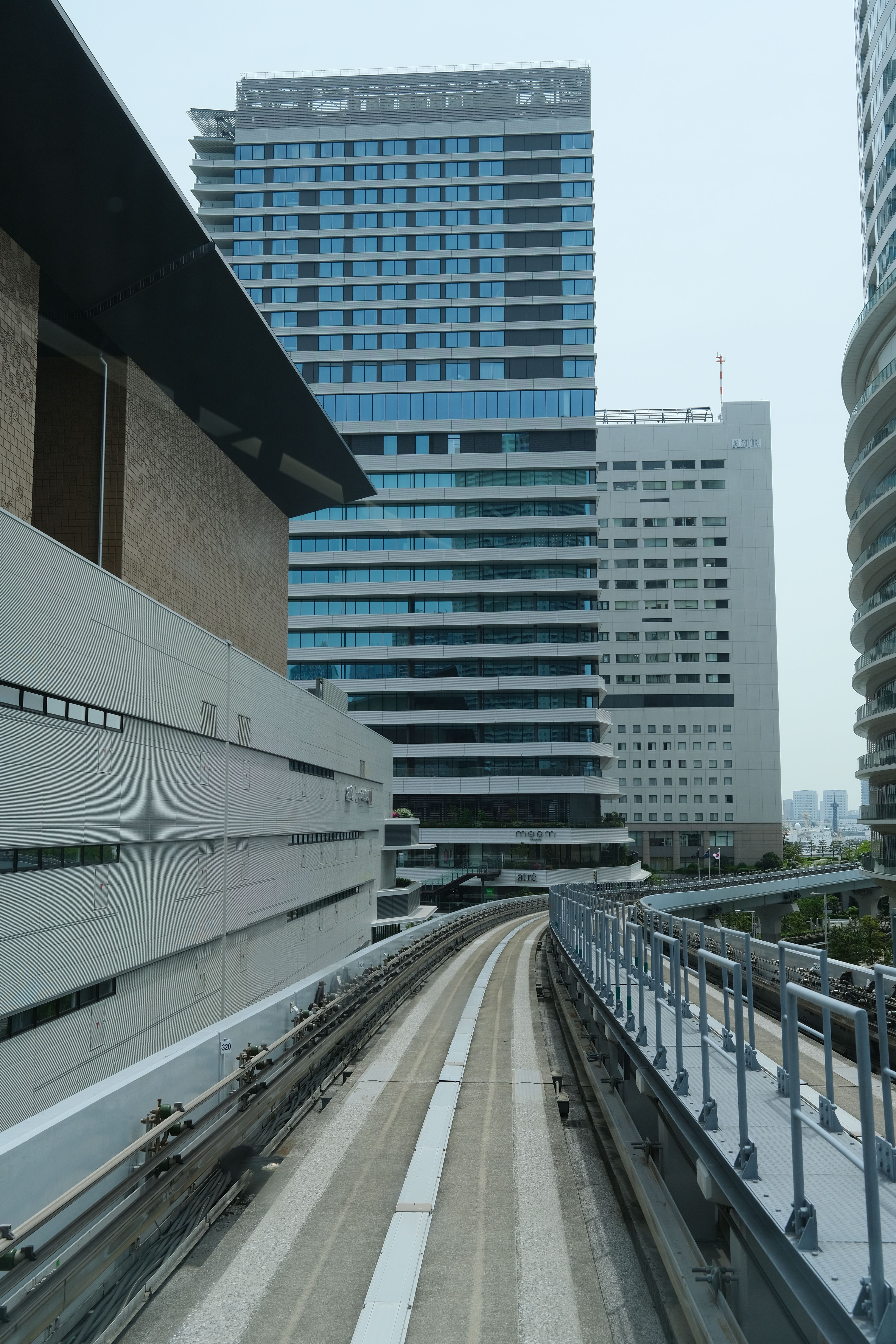 A train tracks going through a city with tall buildings · Free Stock Photo