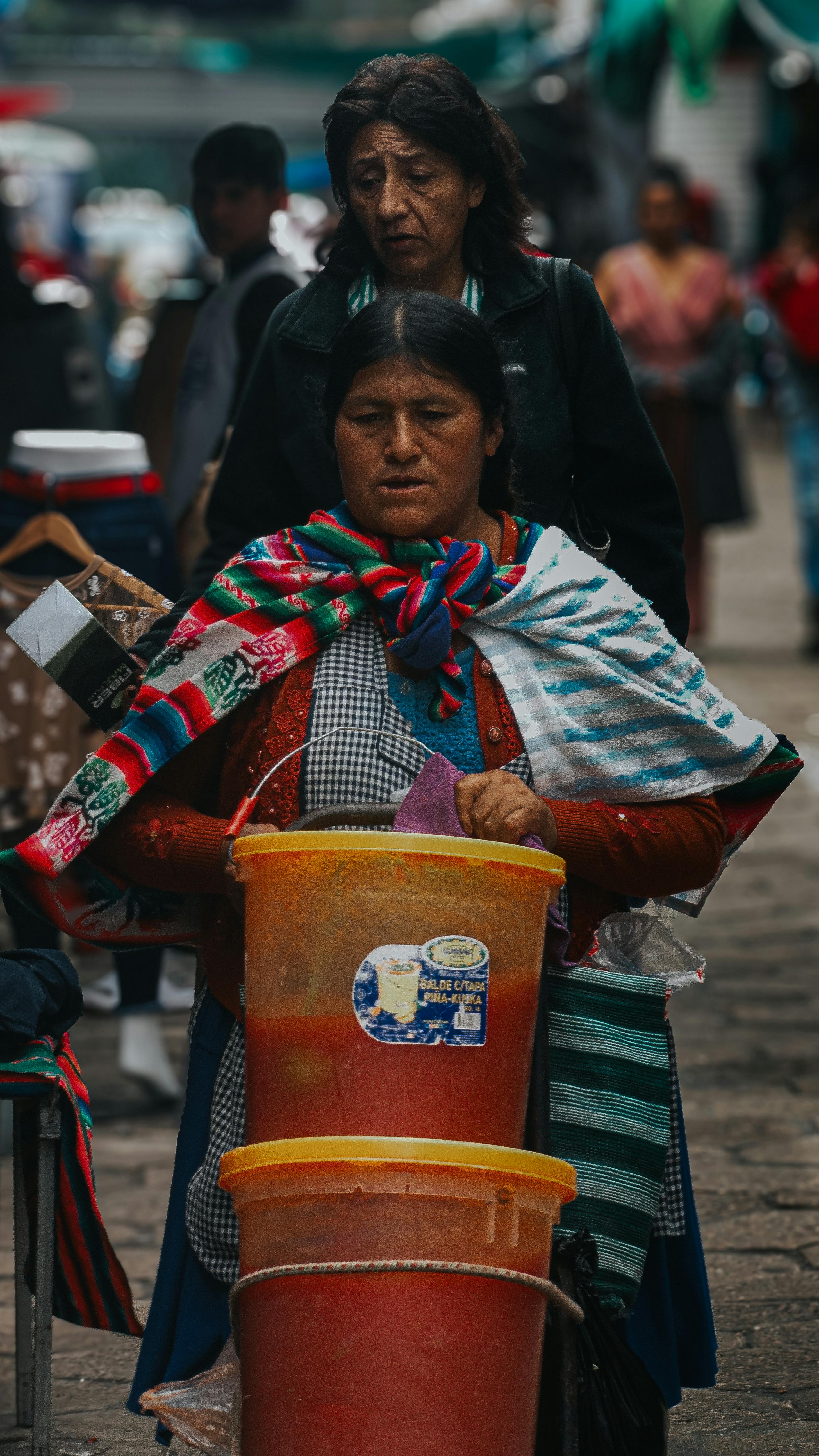 Woman Wearing Traditional Clothing Carrying Buckets with Red Liquid ...