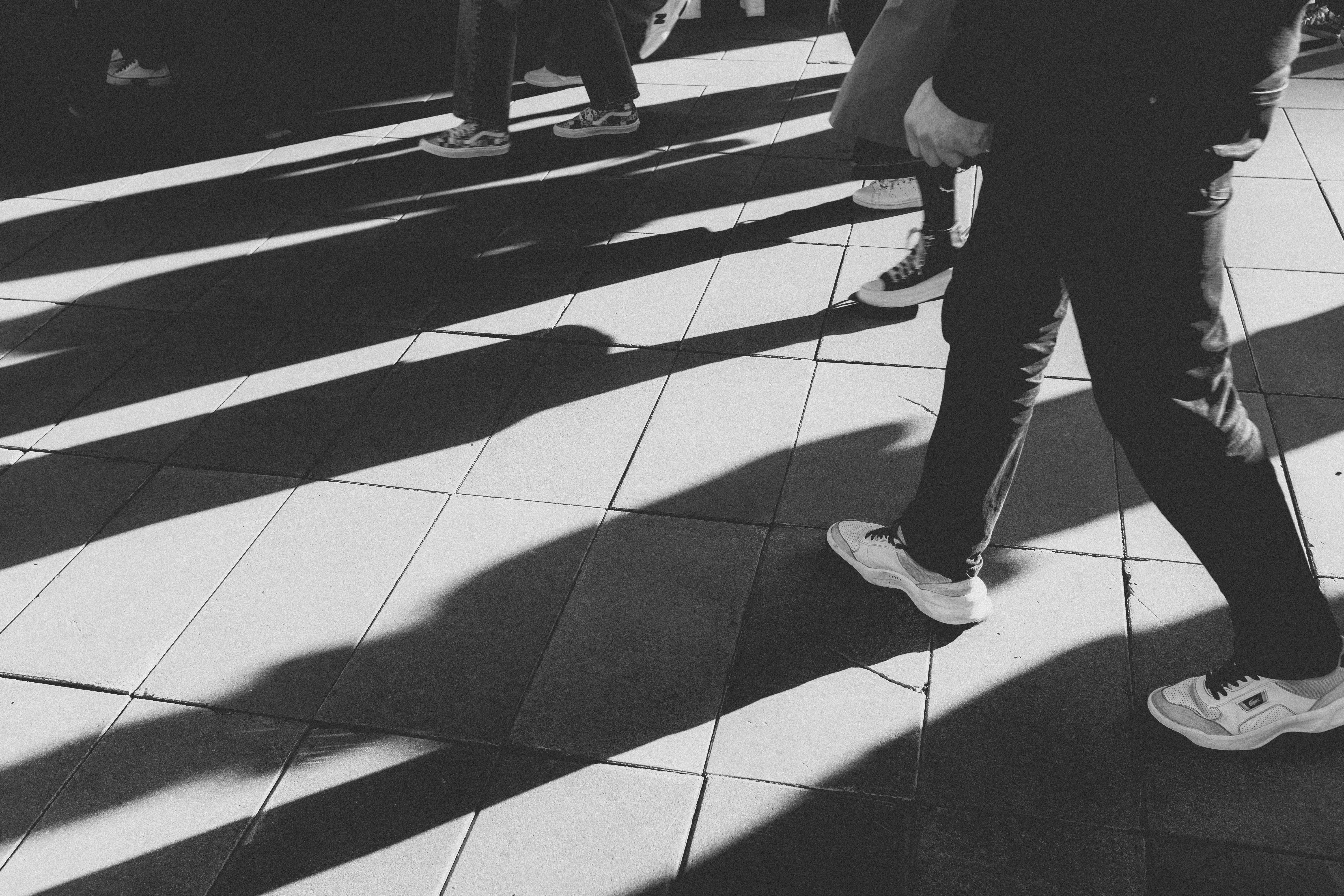 Shadows of People Walking on Pavement · Free Stock Photo
