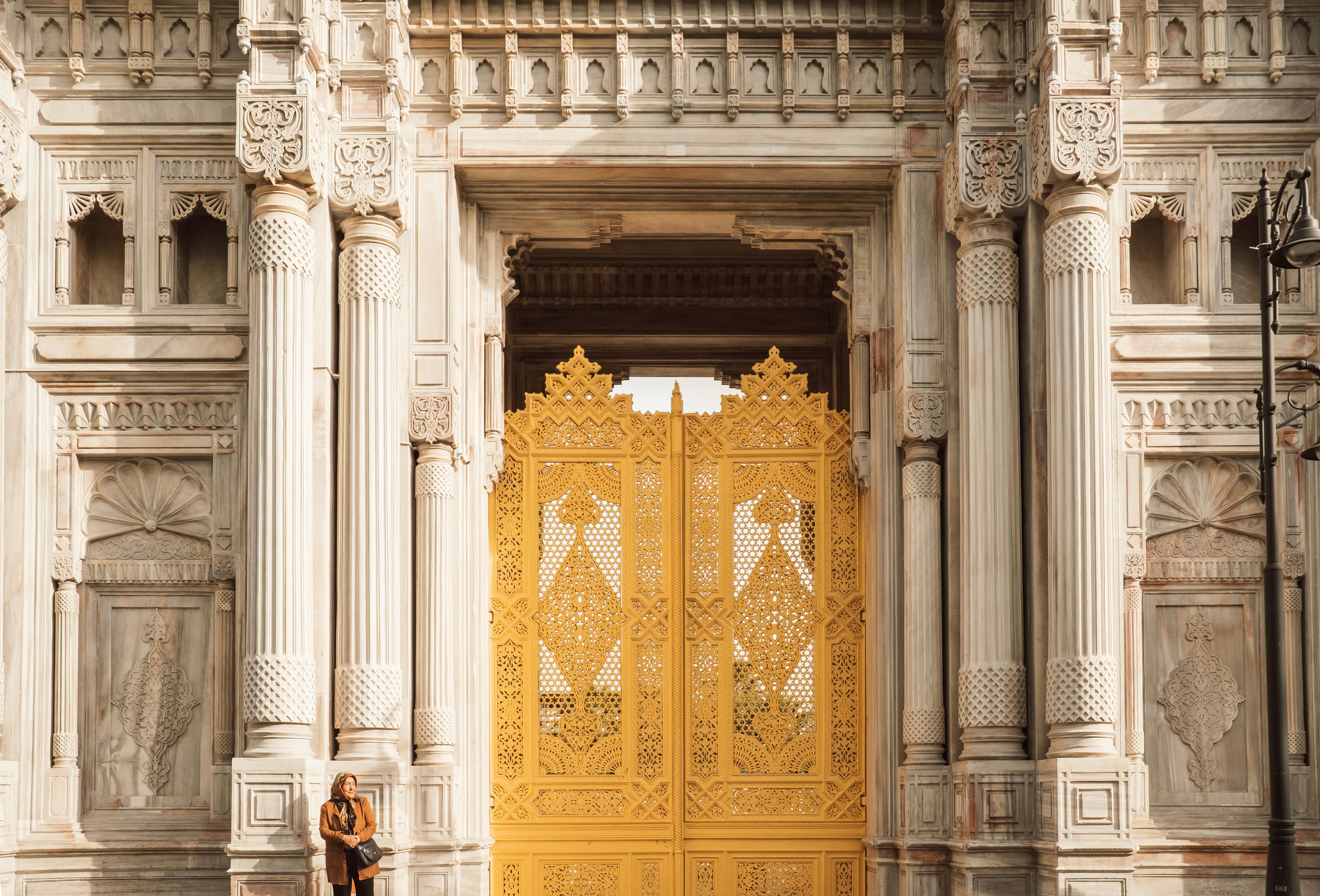 View of a Golden, Ornate Gate and a Facade with Architectural Details ...
