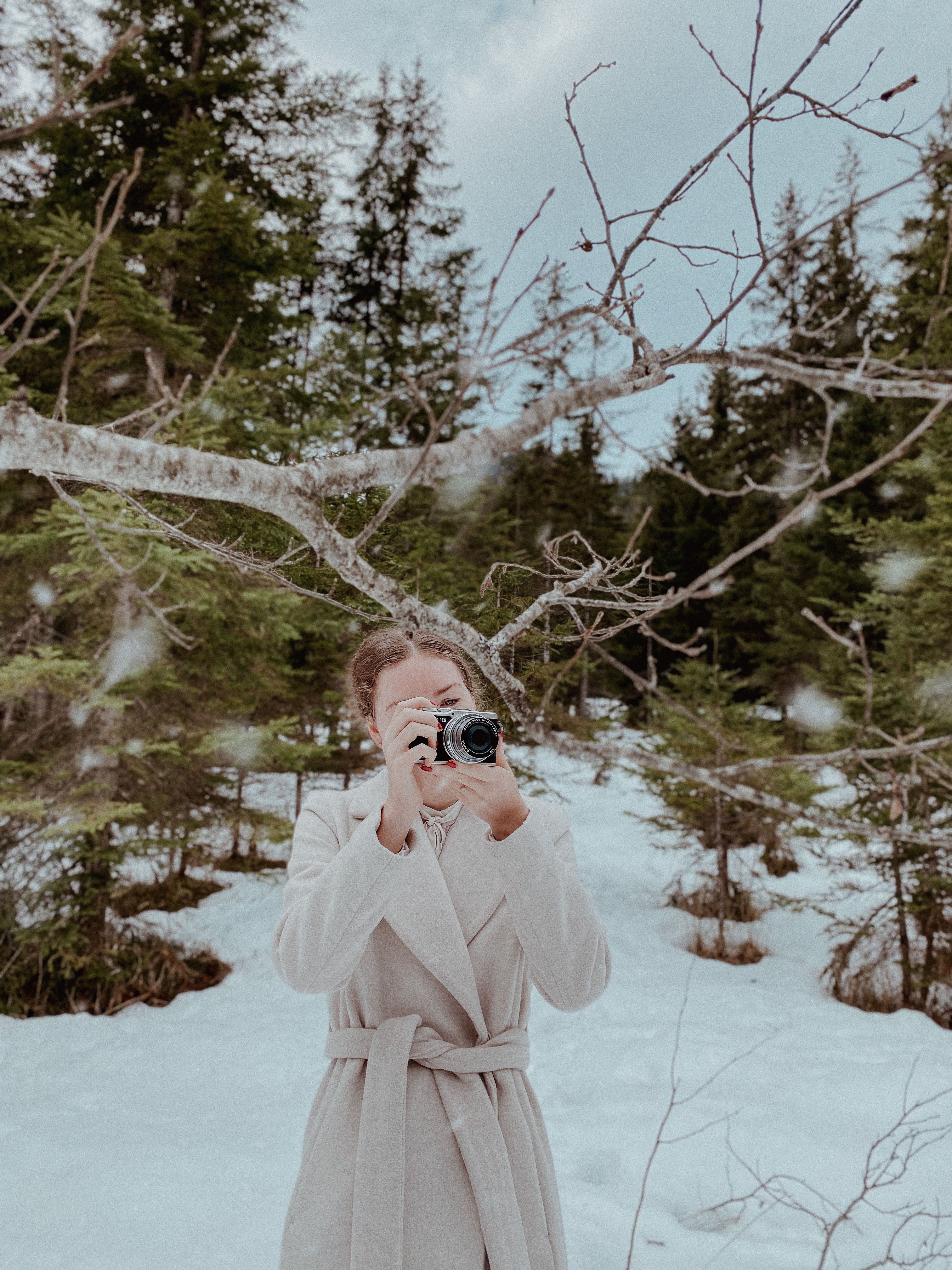 A woman taking a picture in the snow · Free Stock Photo