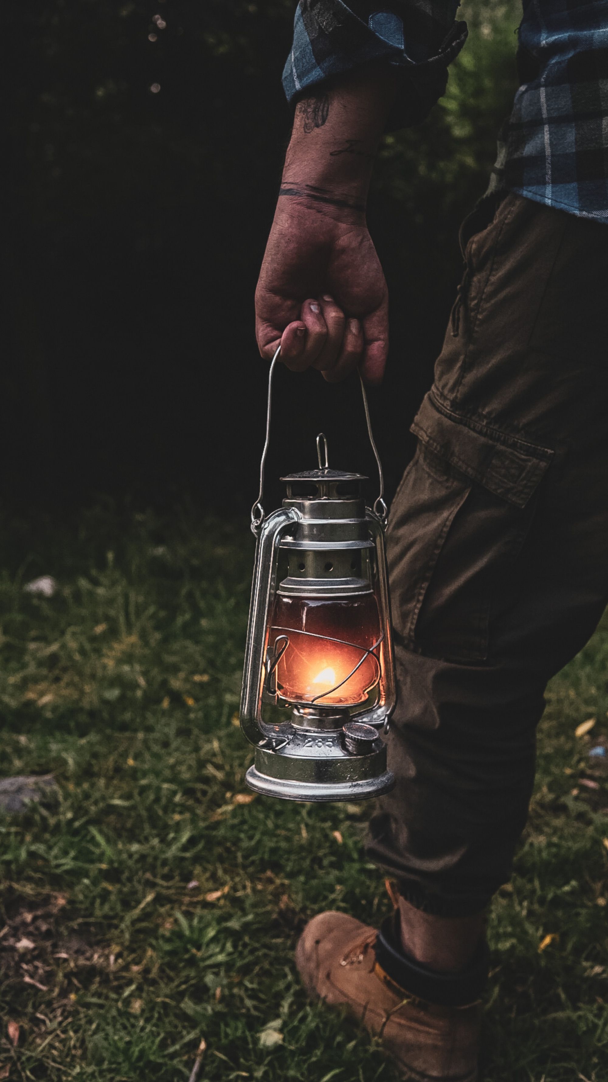 Mans Hand Holding an Old Lantern in the Forest · Free Stock Photo