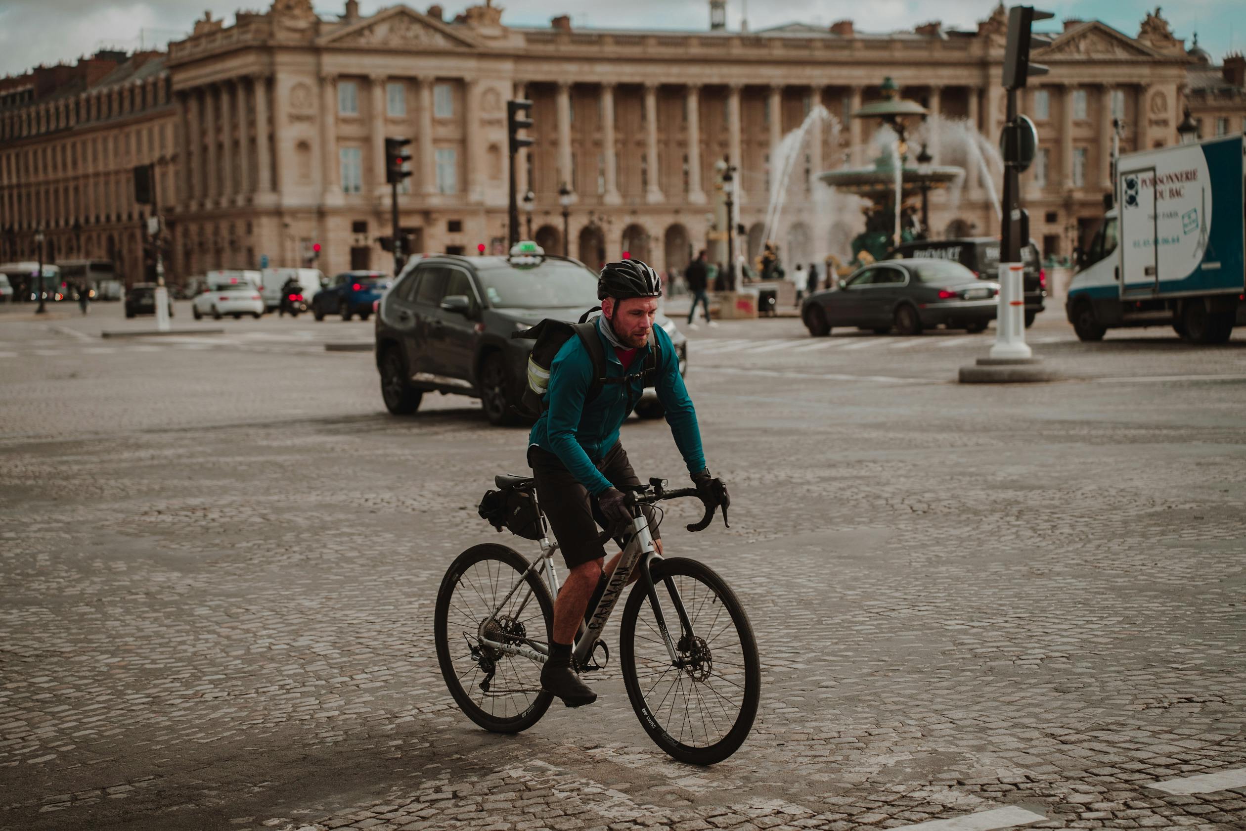 Man Cycling on the Cobblestone Street in Front of the Hotel de Crillon ...