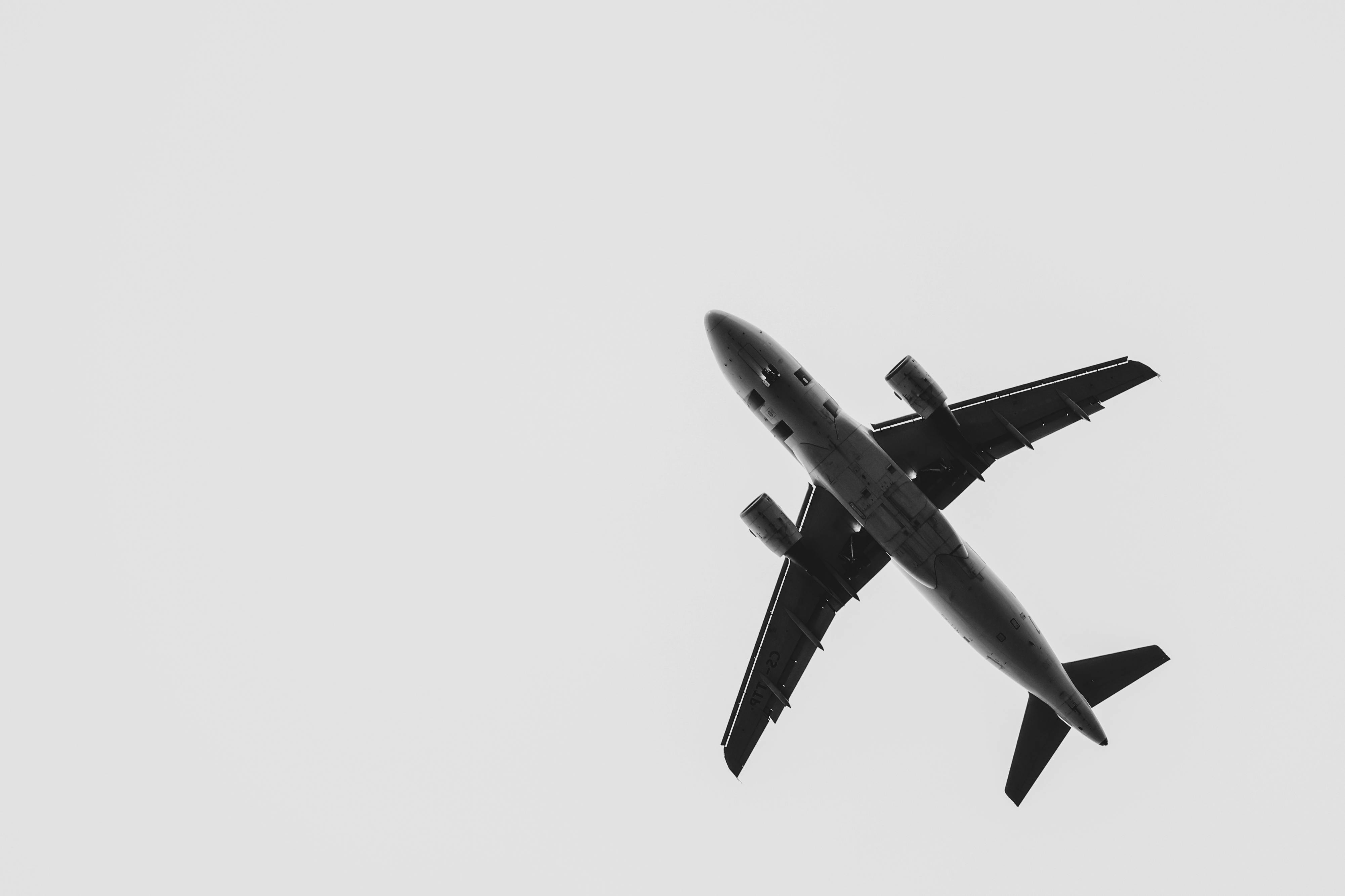 Bottom View of Plane Flying Through Sky · Free Stock Photo