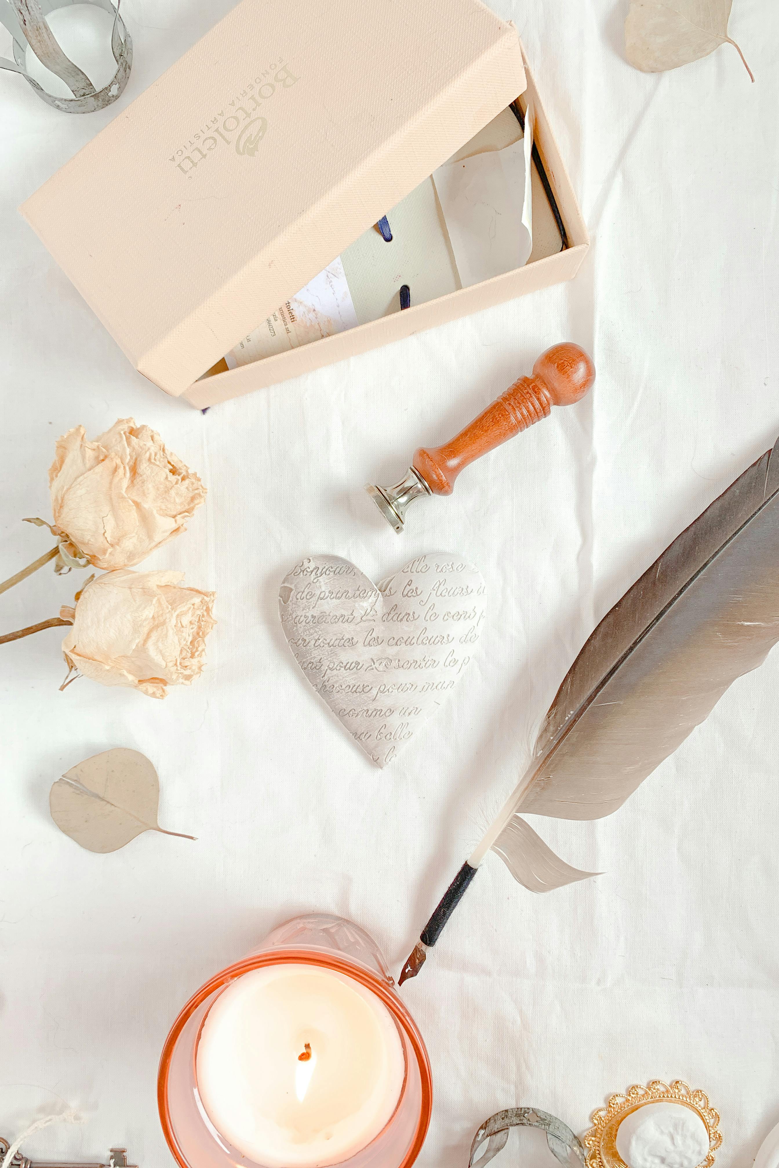 Heart Next to Stomp and Quill on Table · Free Stock Photo
