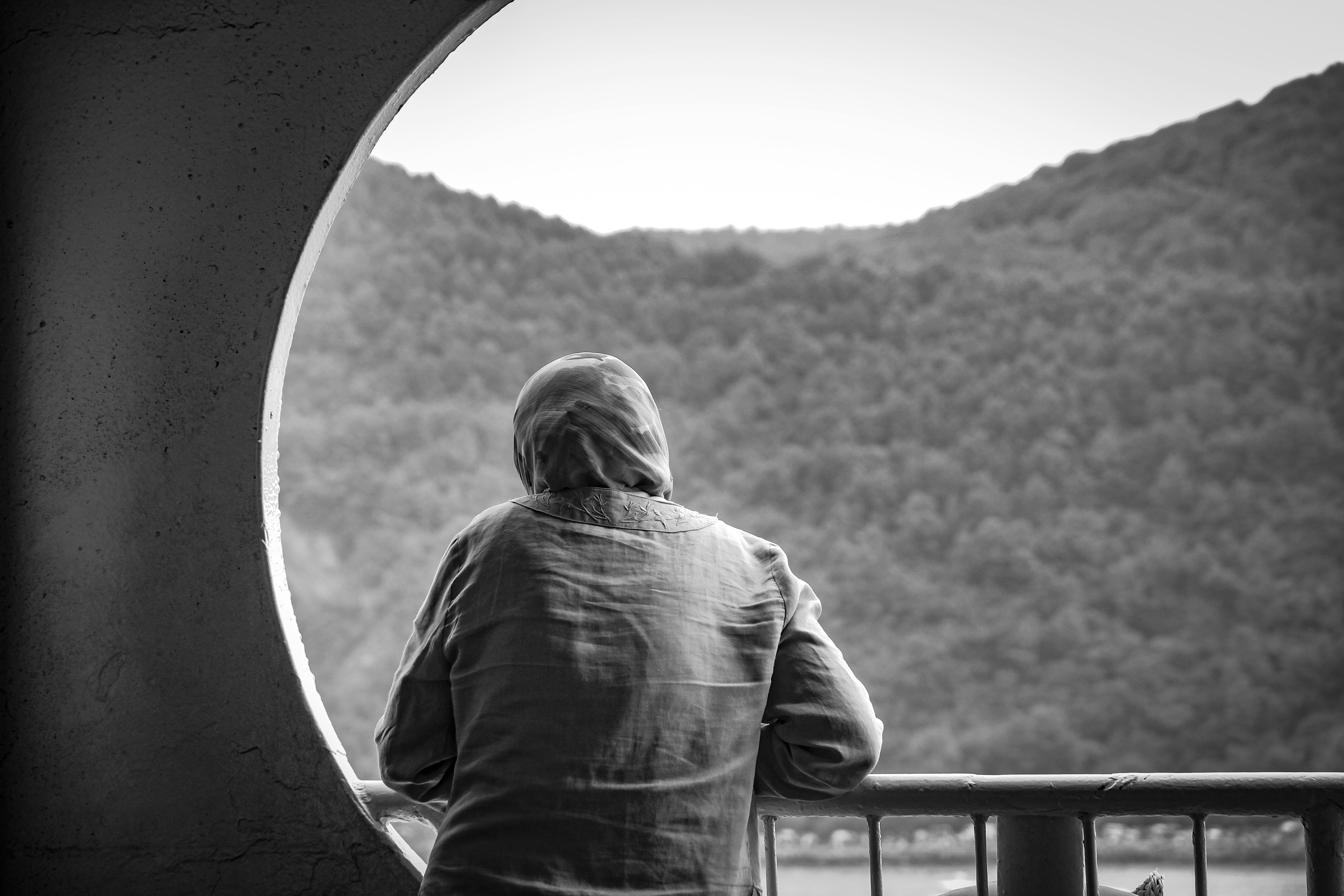 A person looking outside a window · Free Stock Photo
