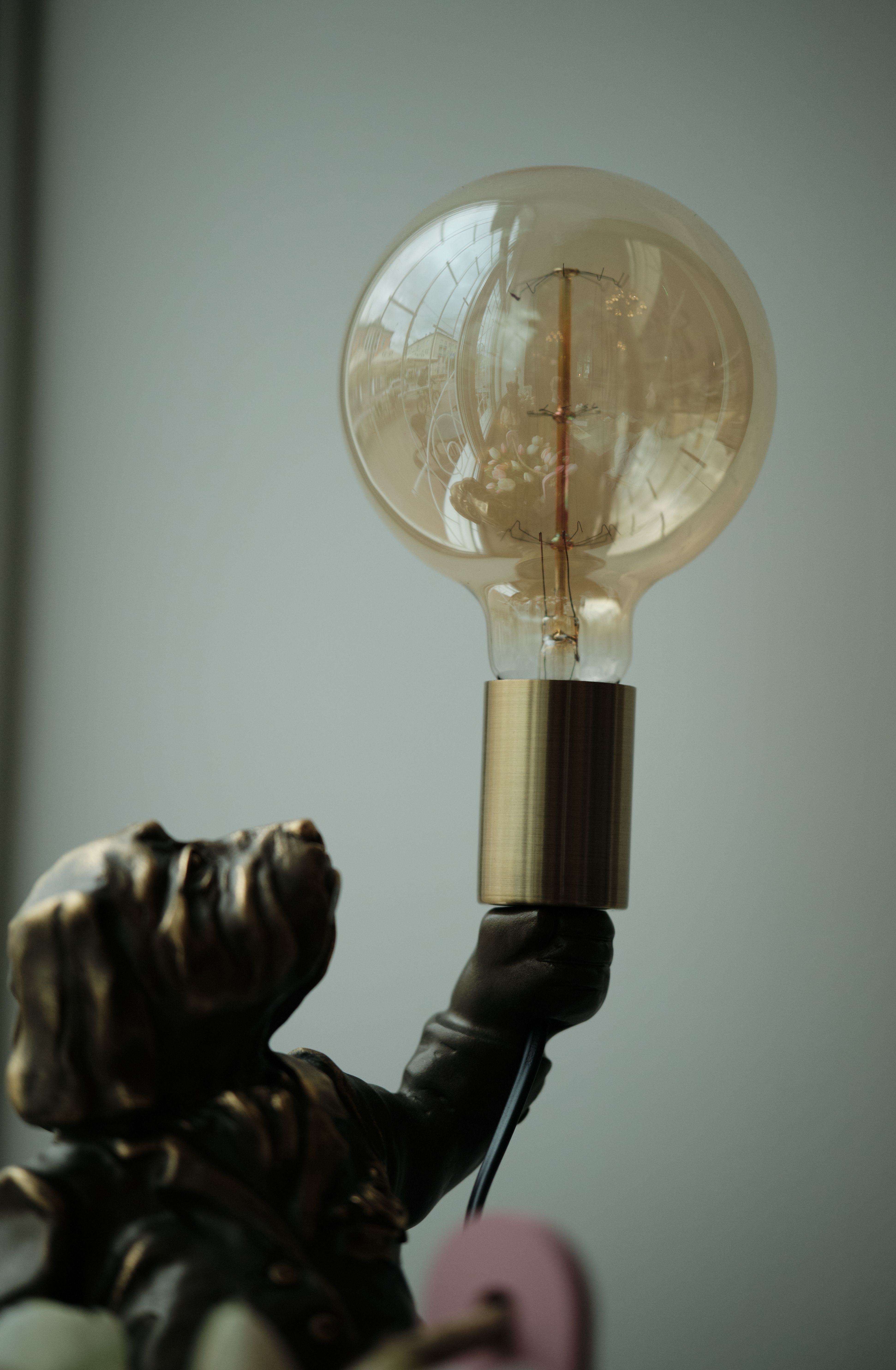 Bronze Dog Holding Light Bulb Decorative Lamp · Free Stock Photo
