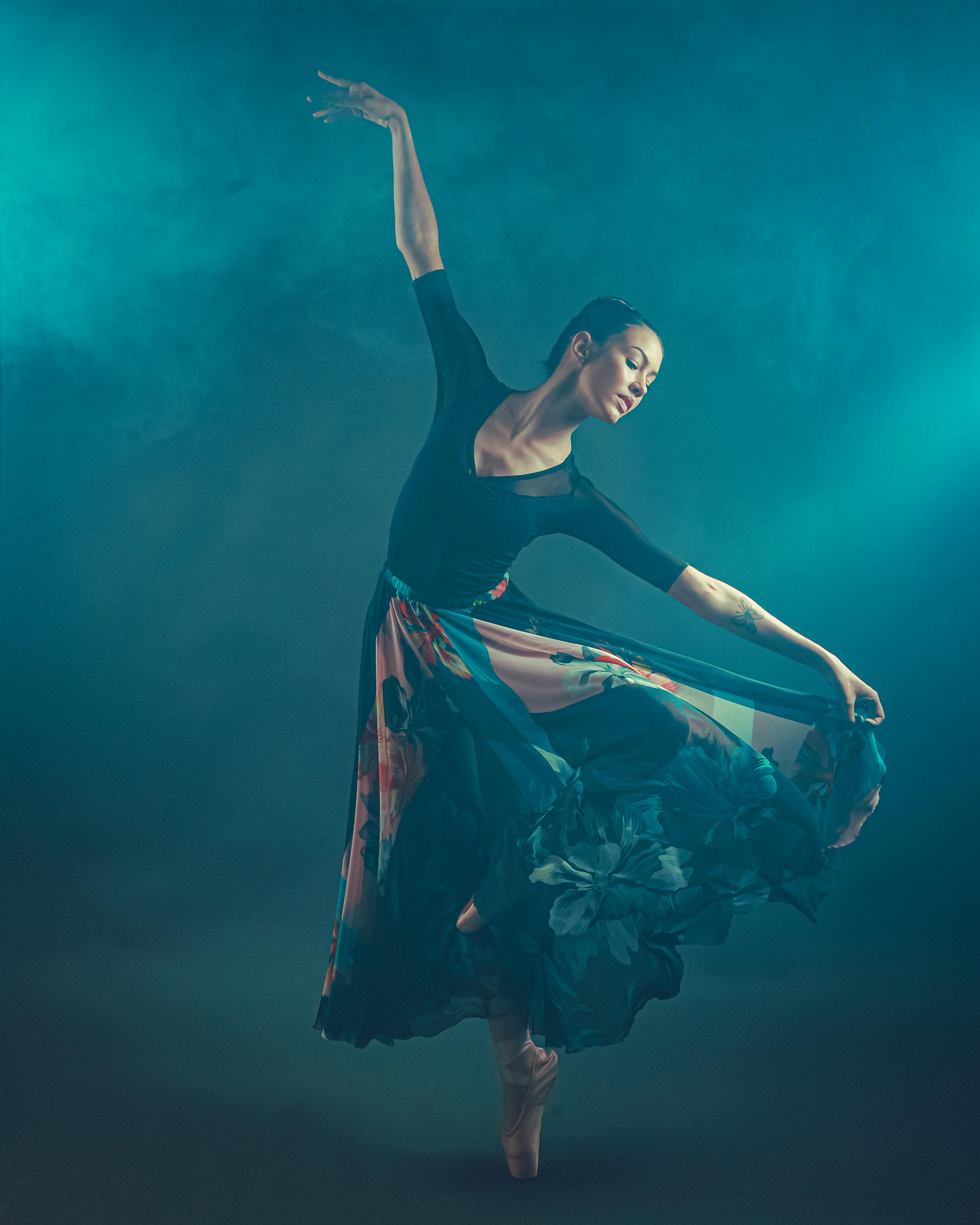 A Ballerina Dancing in Blue Lighting and Smoke · Free Stock Photo