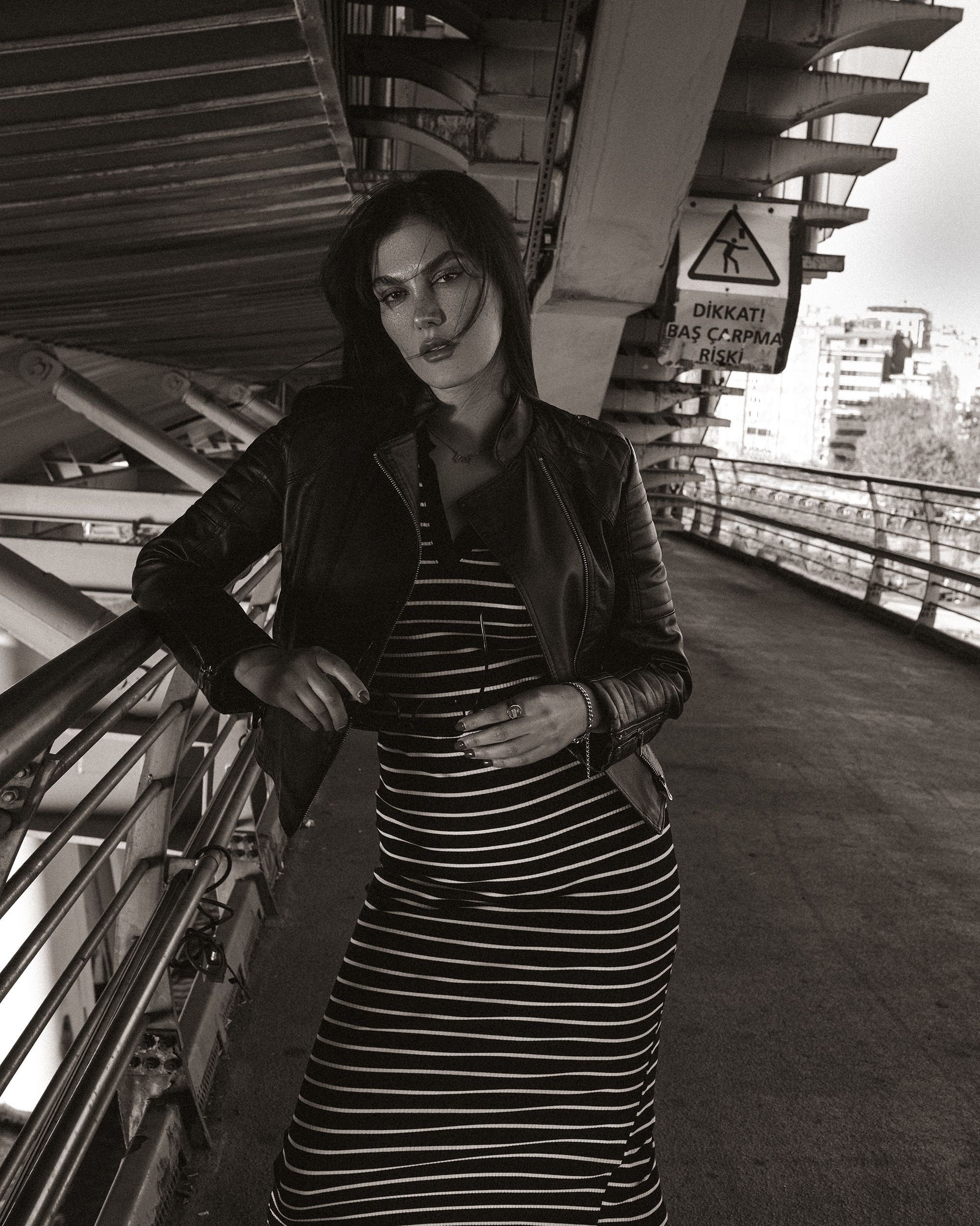Model in Striped Dress and Leather Jacket on the Bridge · Free Stock Photo