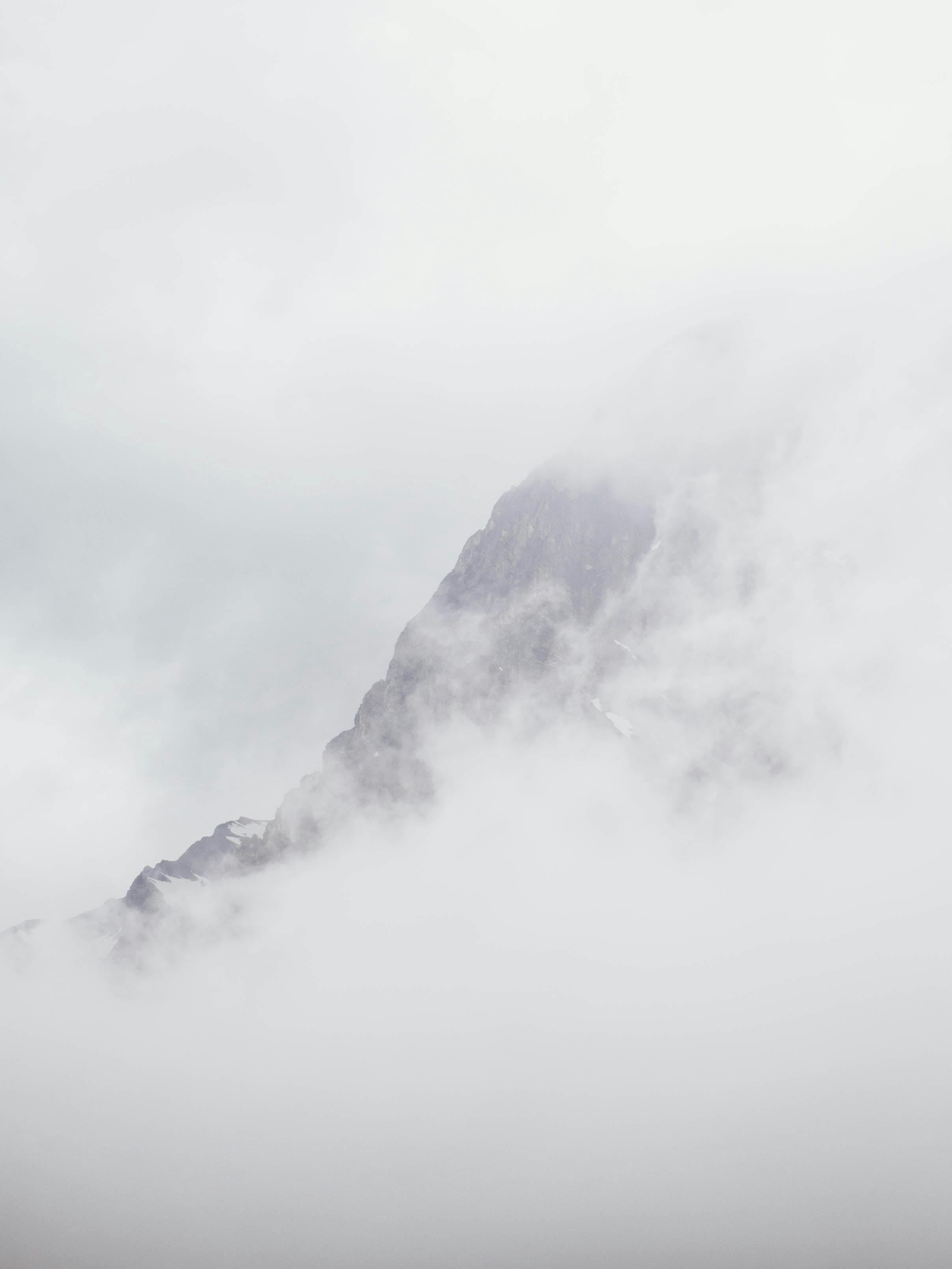 Mountain Coated With Snow Under Gray Sky · Free Stock Photo