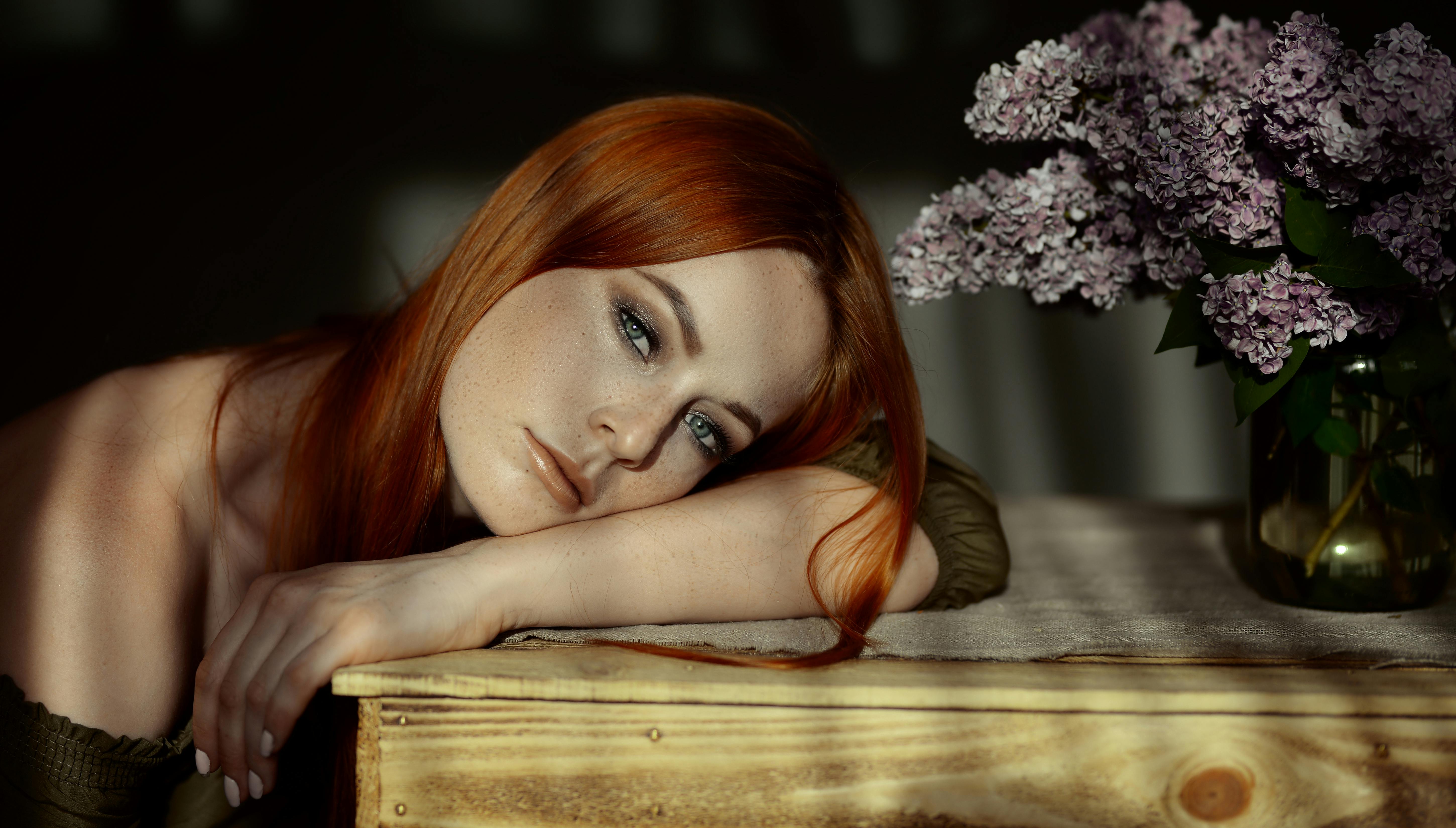 Woman wearing an off shoulder top lying on a table · Free Stock Photo