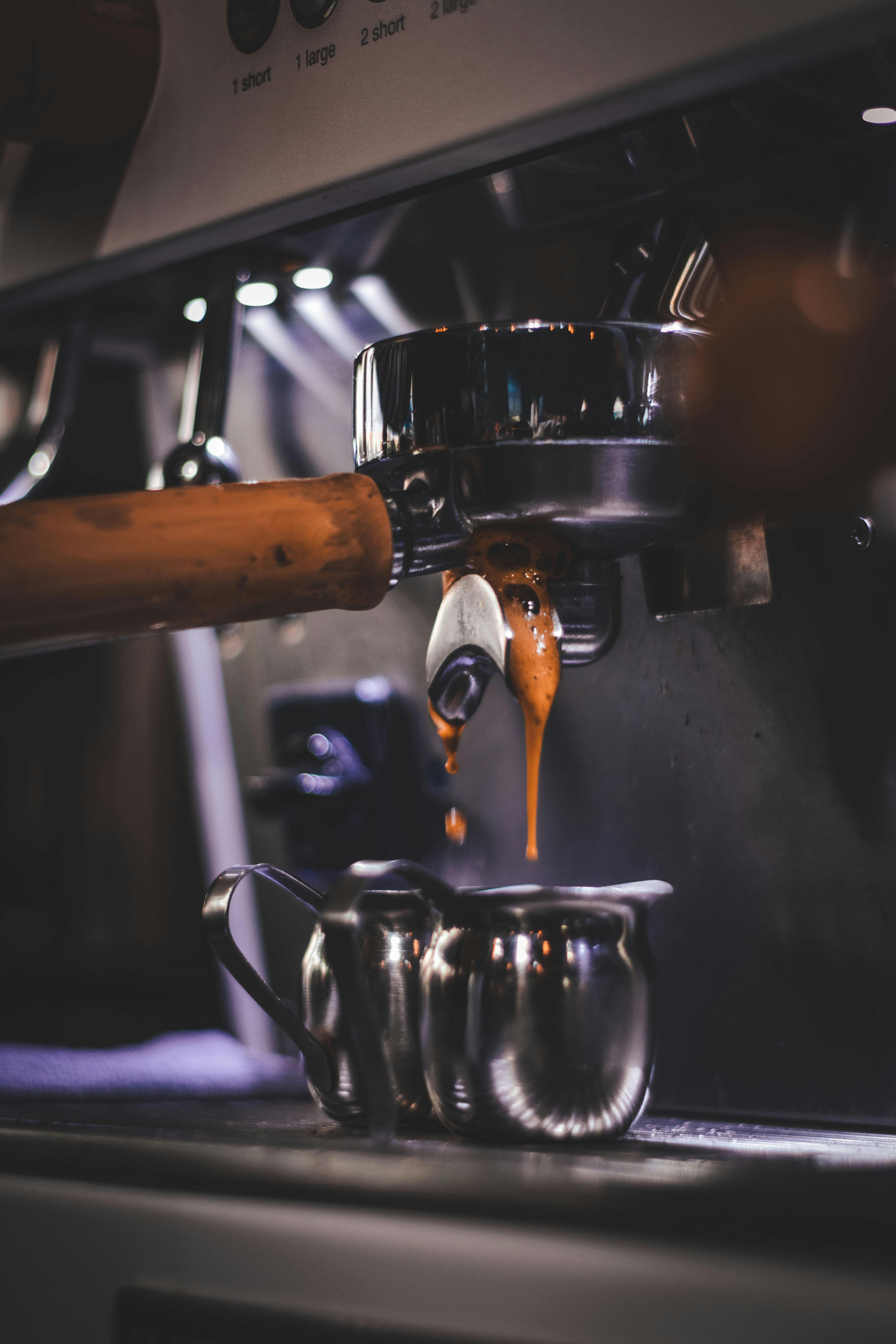 Pitchers Filled in a Coffee Machine · Free Stock Photo
