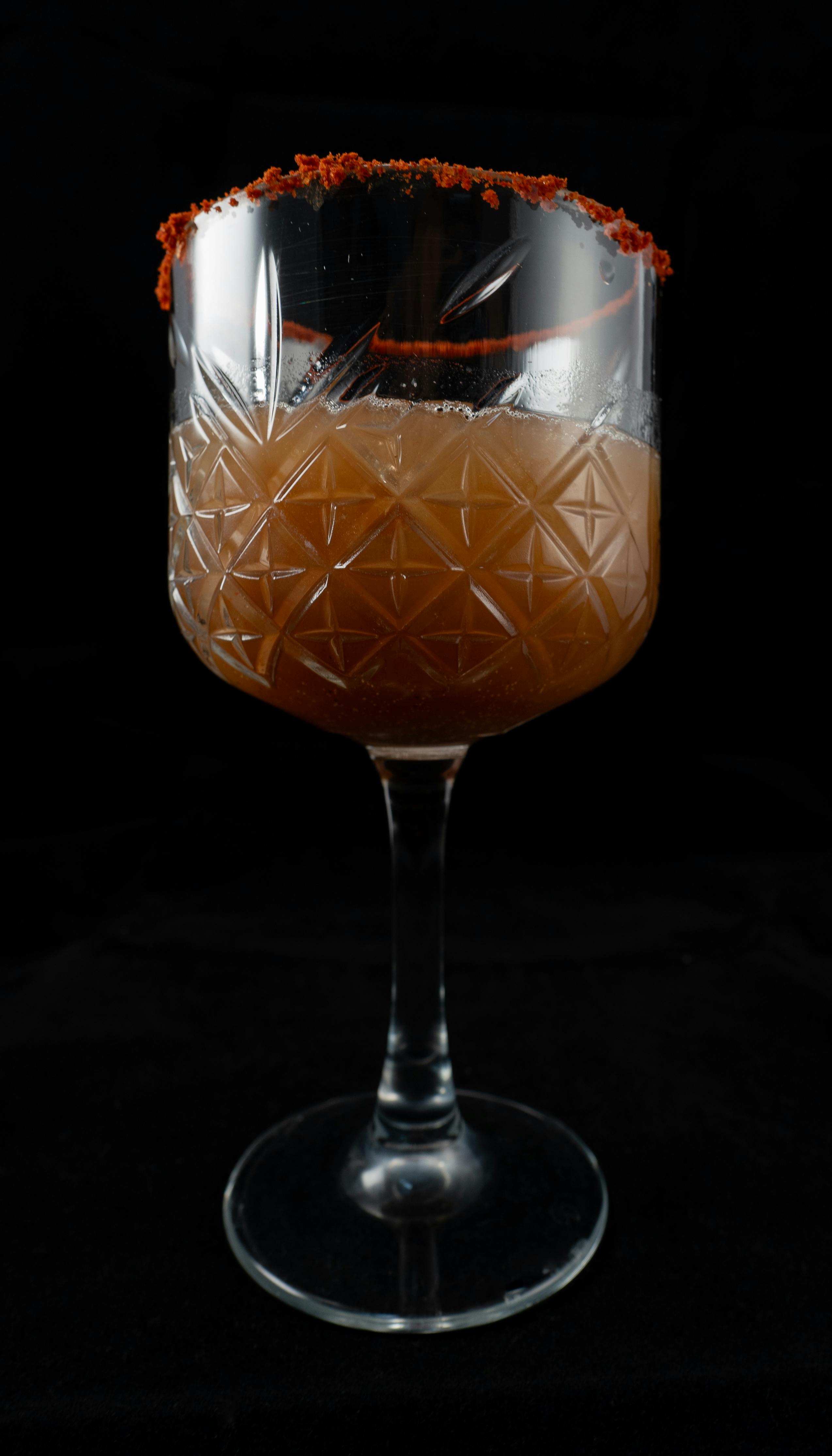 Glass of Brown Cocktail with Cayenne Pepper on the Rim · Free Stock Photo