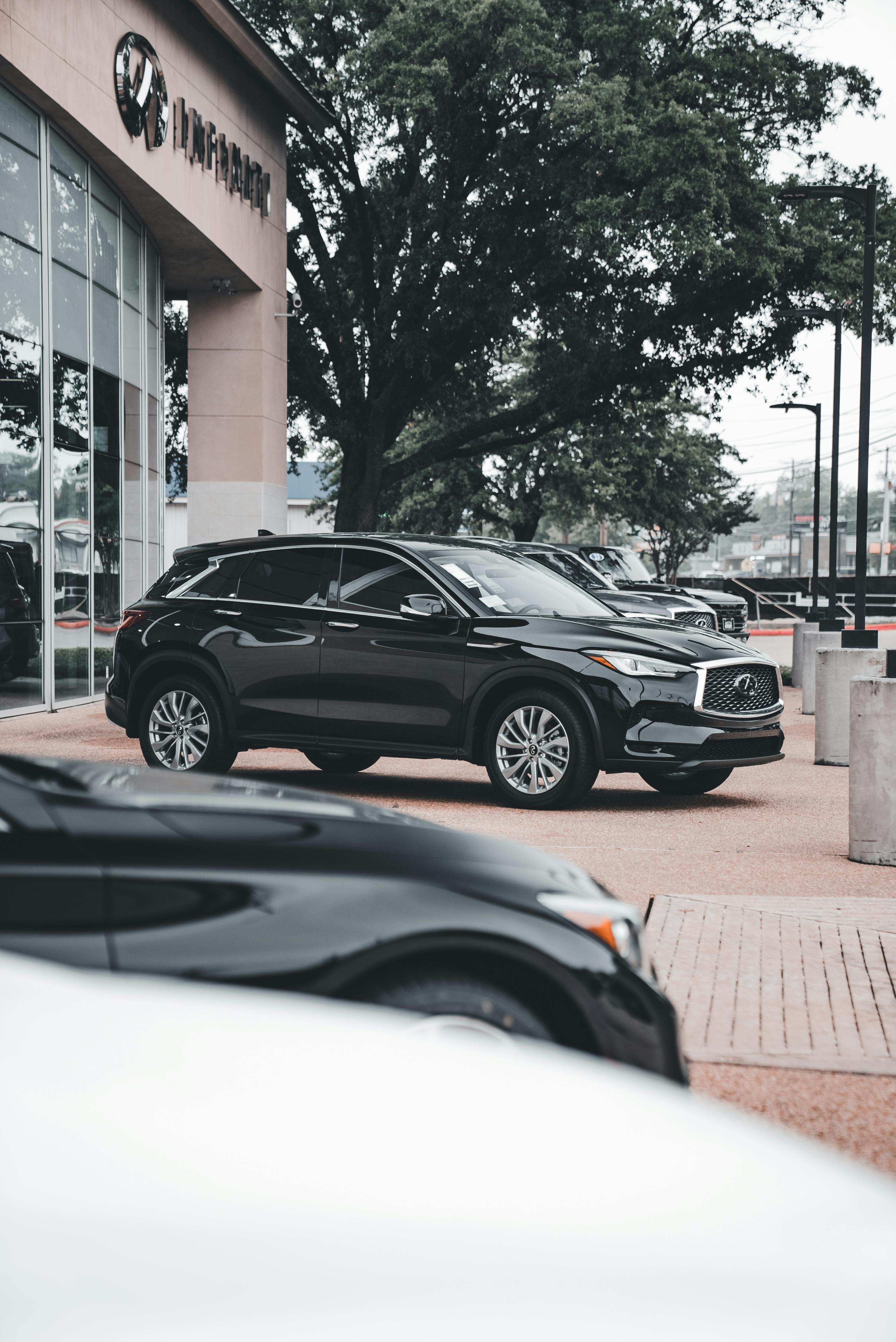 Black Car Outside a Car Dealership · Free Stock Photo