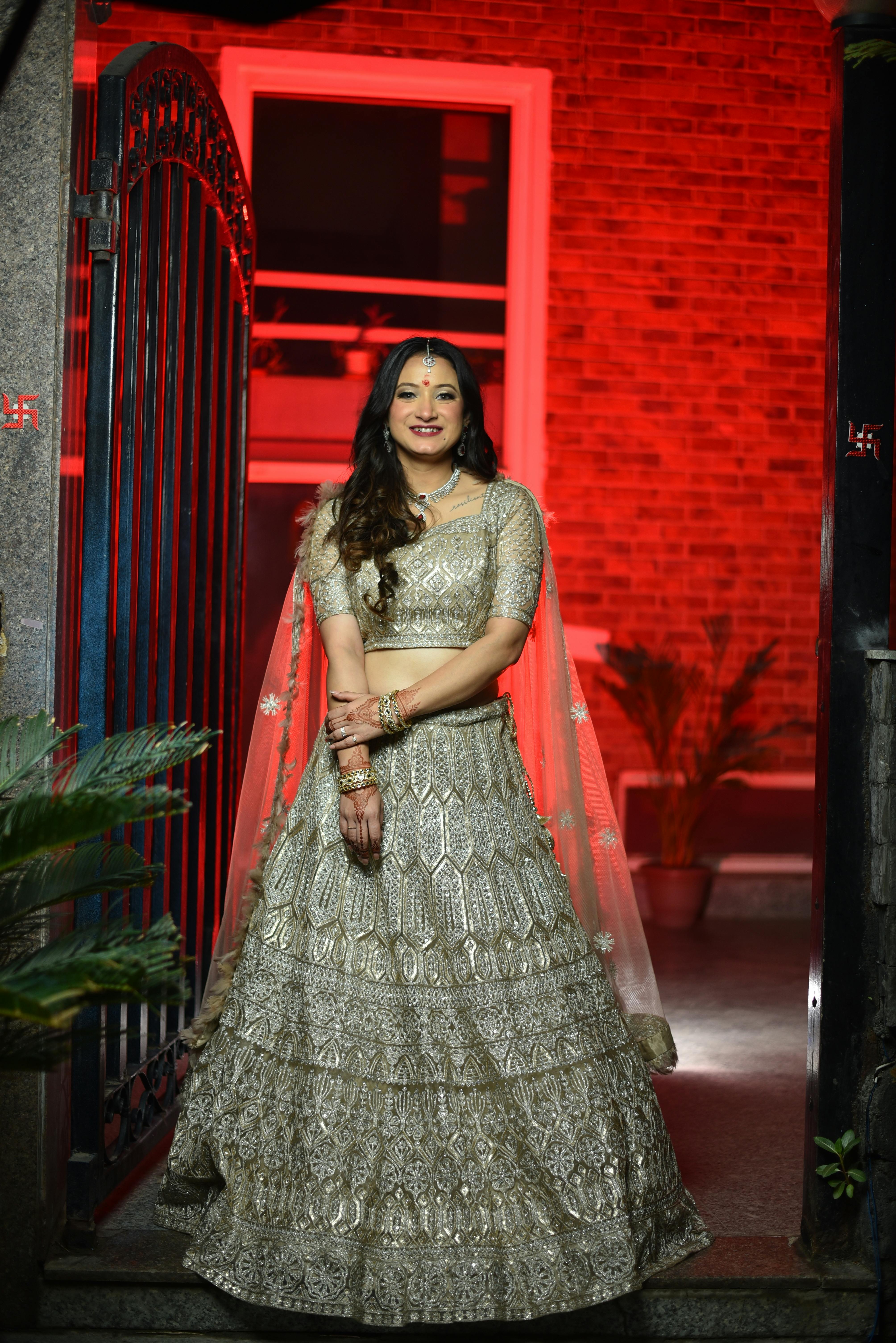 Woman in Silver Sari Standing under Wall Illuminated with Red Light ...
