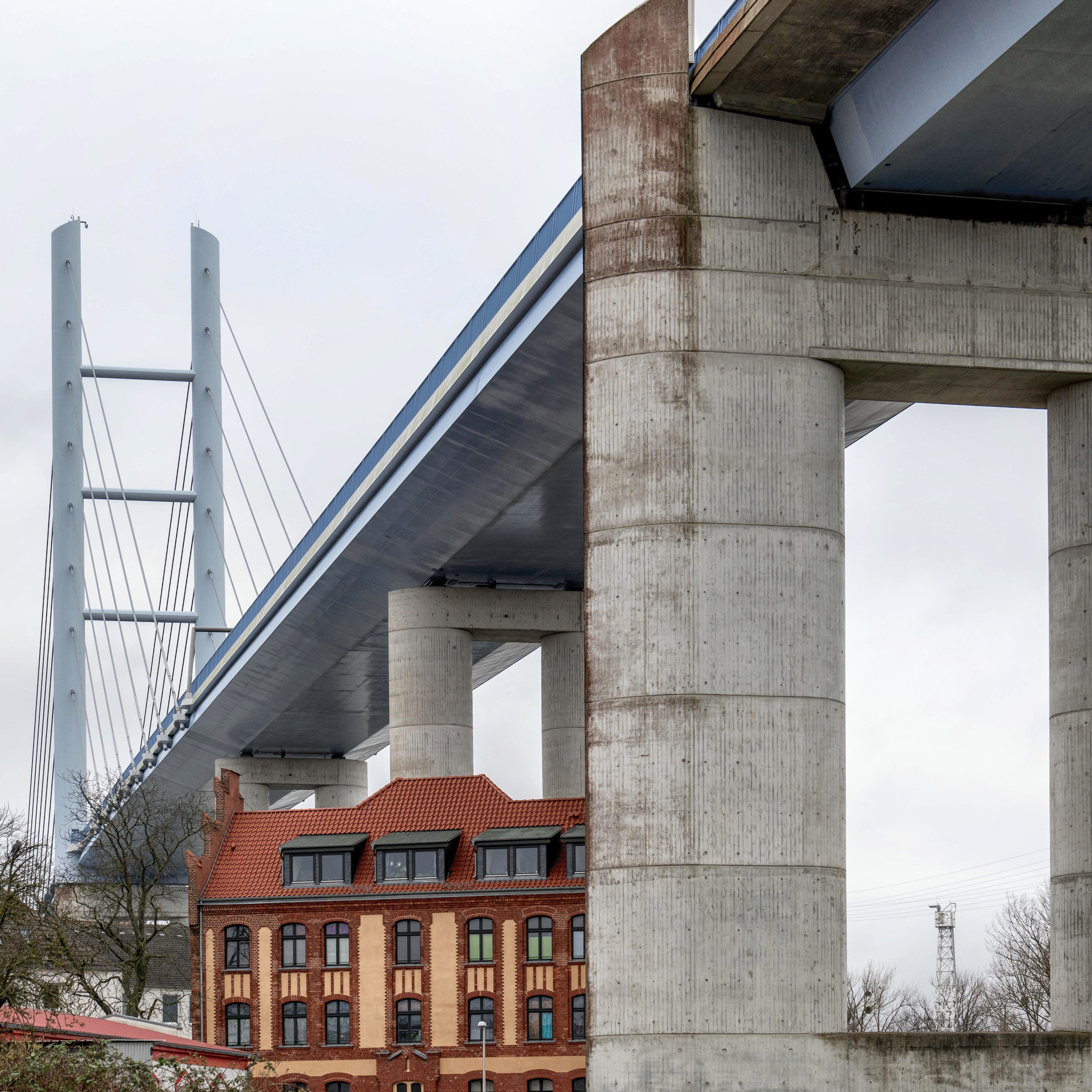 House Built under Suspension Bridge · Free Stock Photo