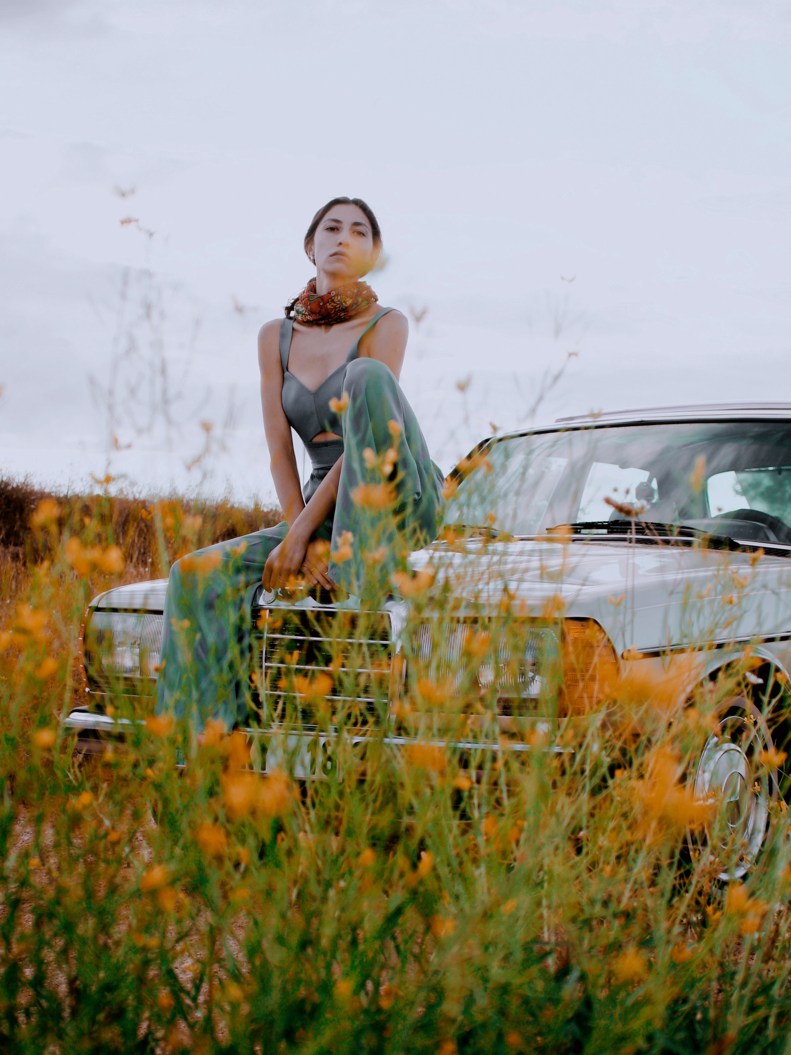 Woman Relaxing Sitting on Classic Car · Free Stock Photo