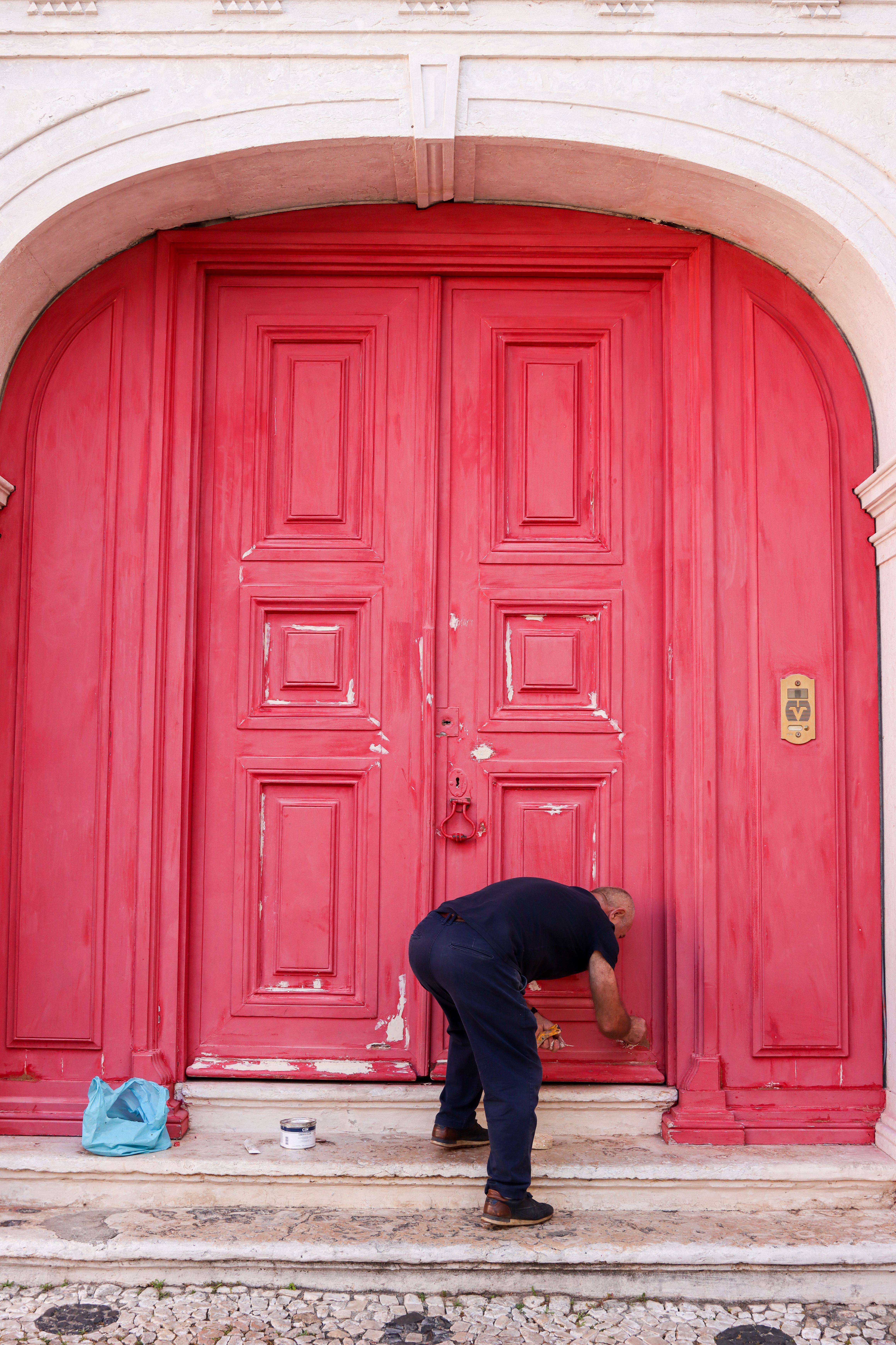 Men Bending under Door and Working · Free Stock Photo