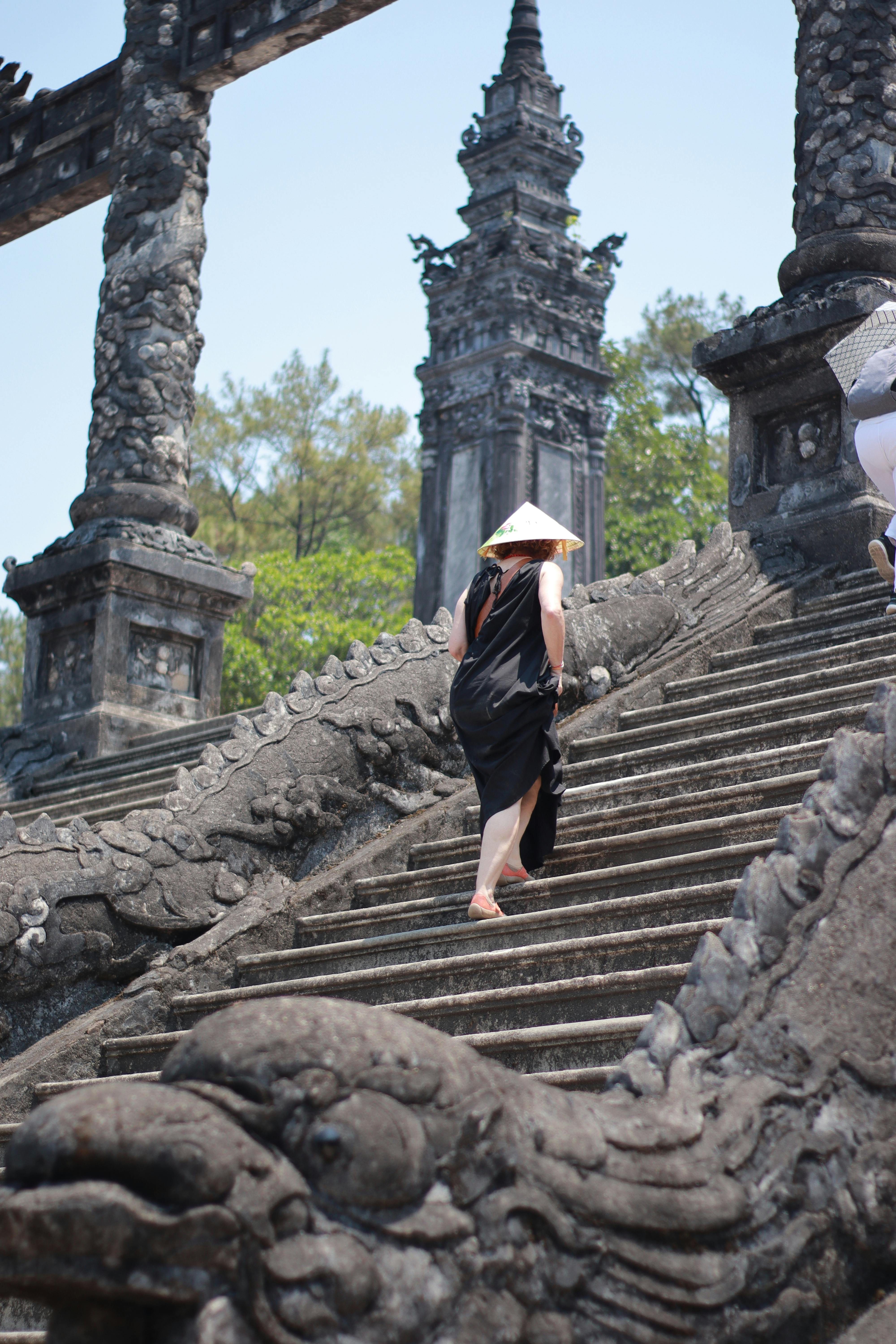 Woman in Conical Hat and Black Dress Walking on Stairs in Hue in ...
