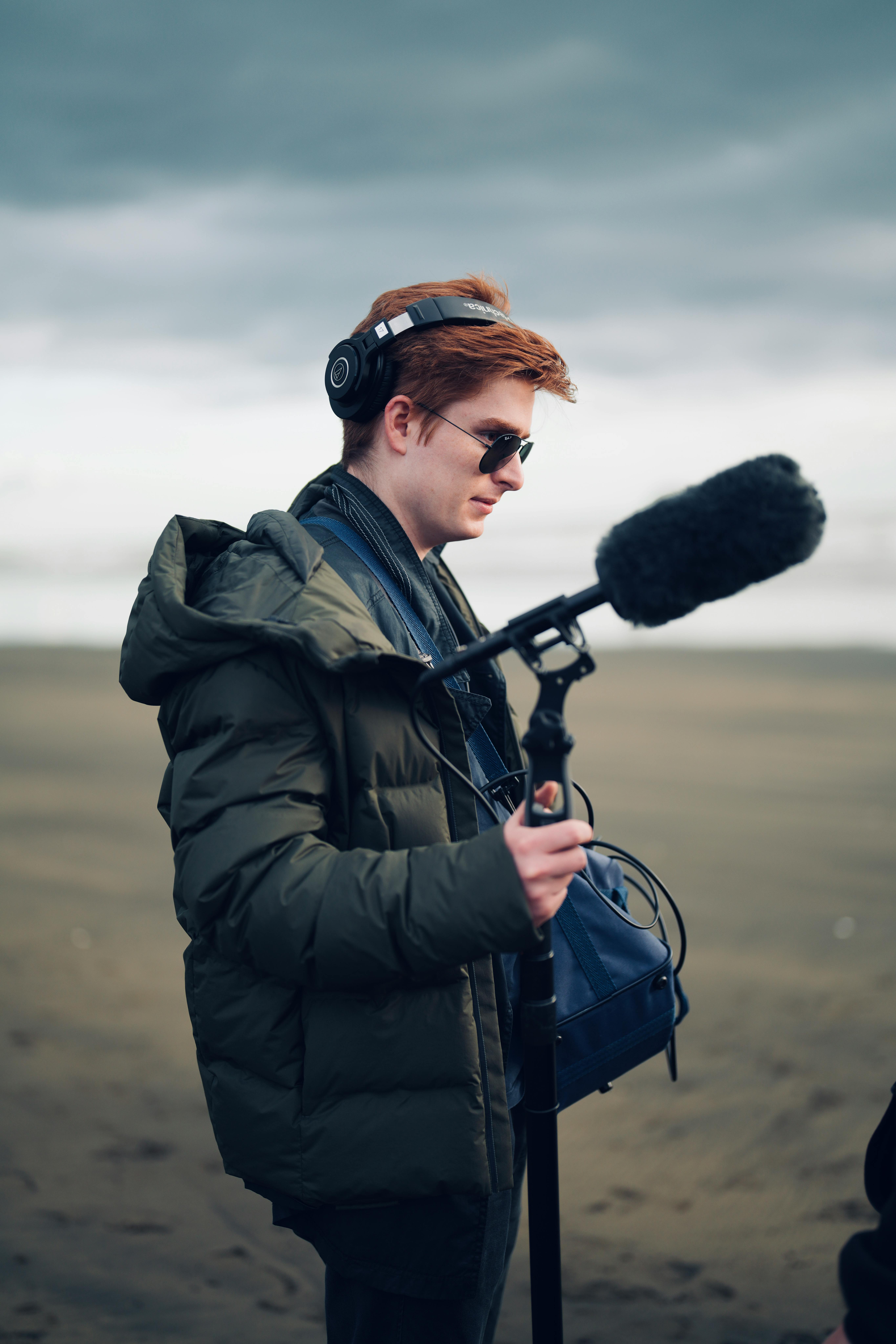 Man with a Microphone on the Beach · Free Stock Photo