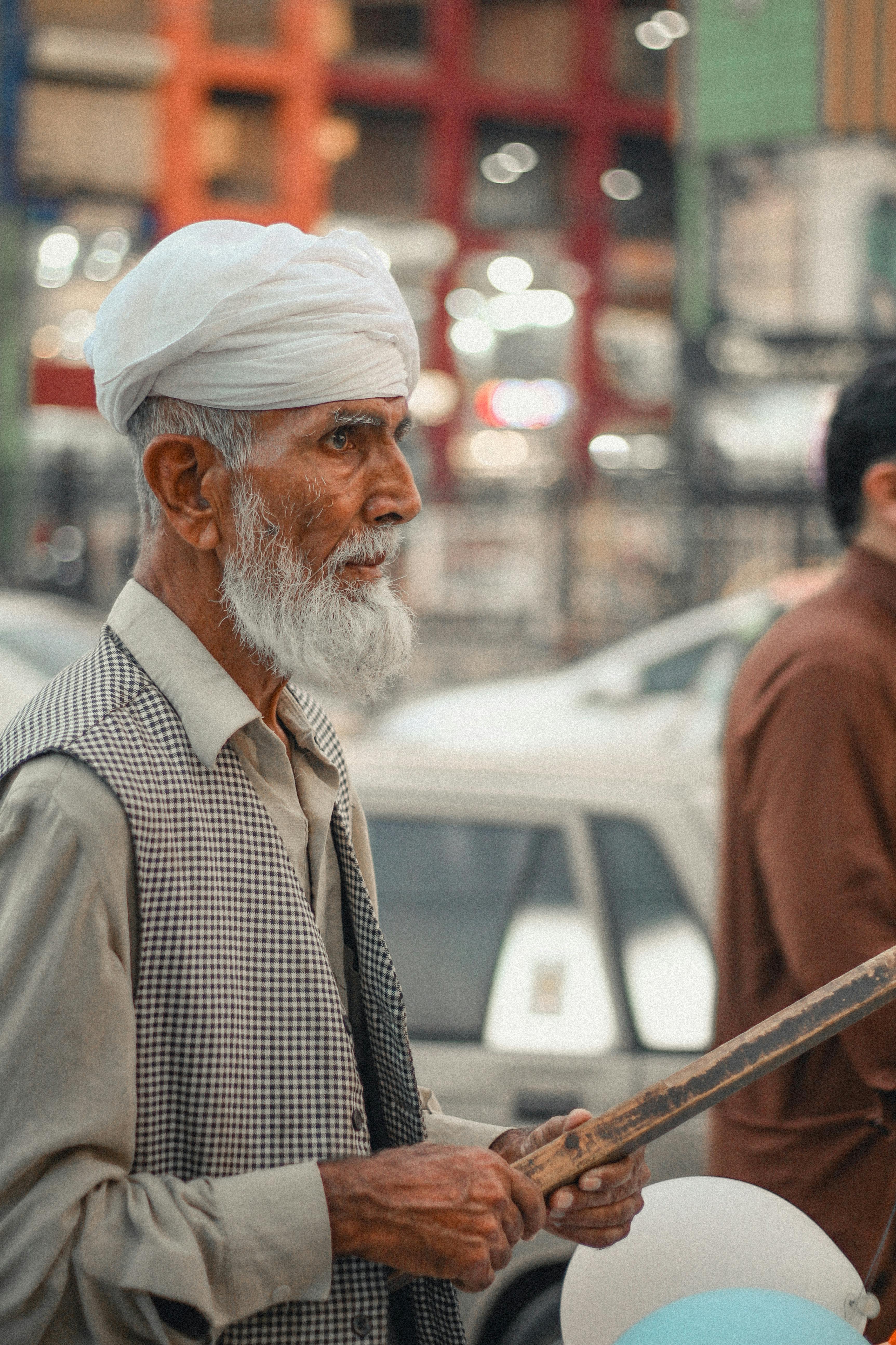 an old man holding stick · Free Stock Photo