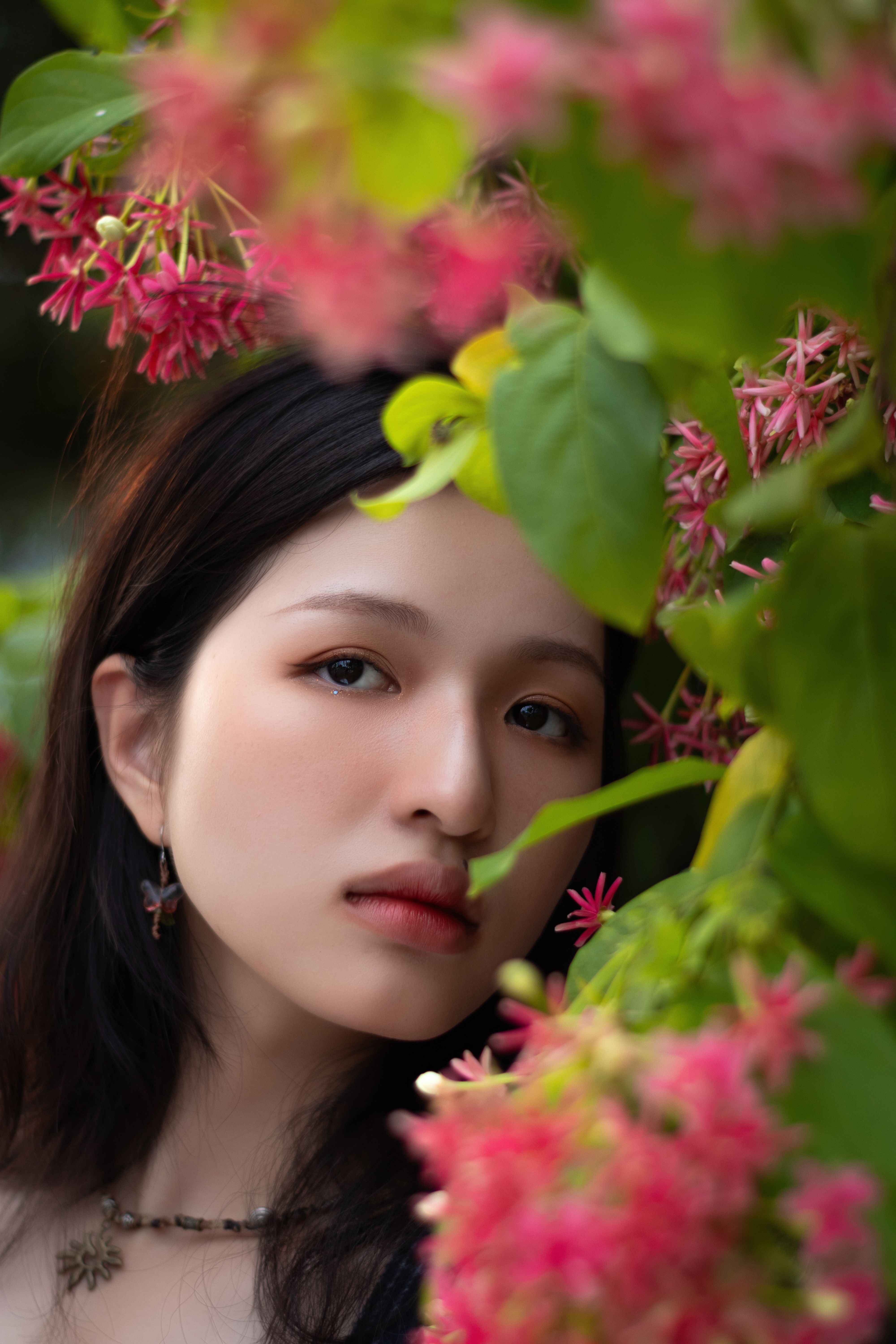 Portrait of Woman behind Flowers · Free Stock Photo