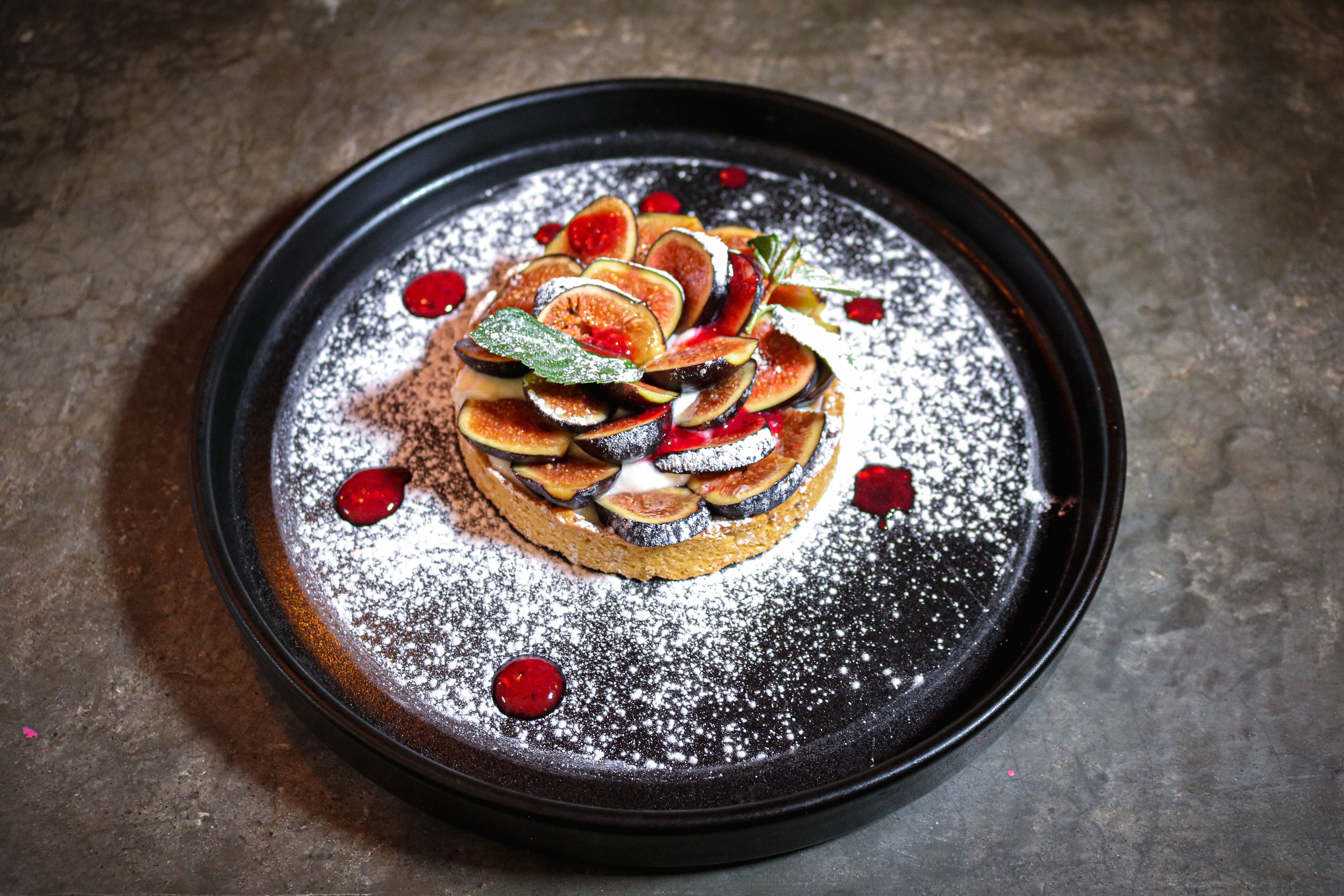 A Dessert with Figs Served on a Black Plate · Free Stock Photo