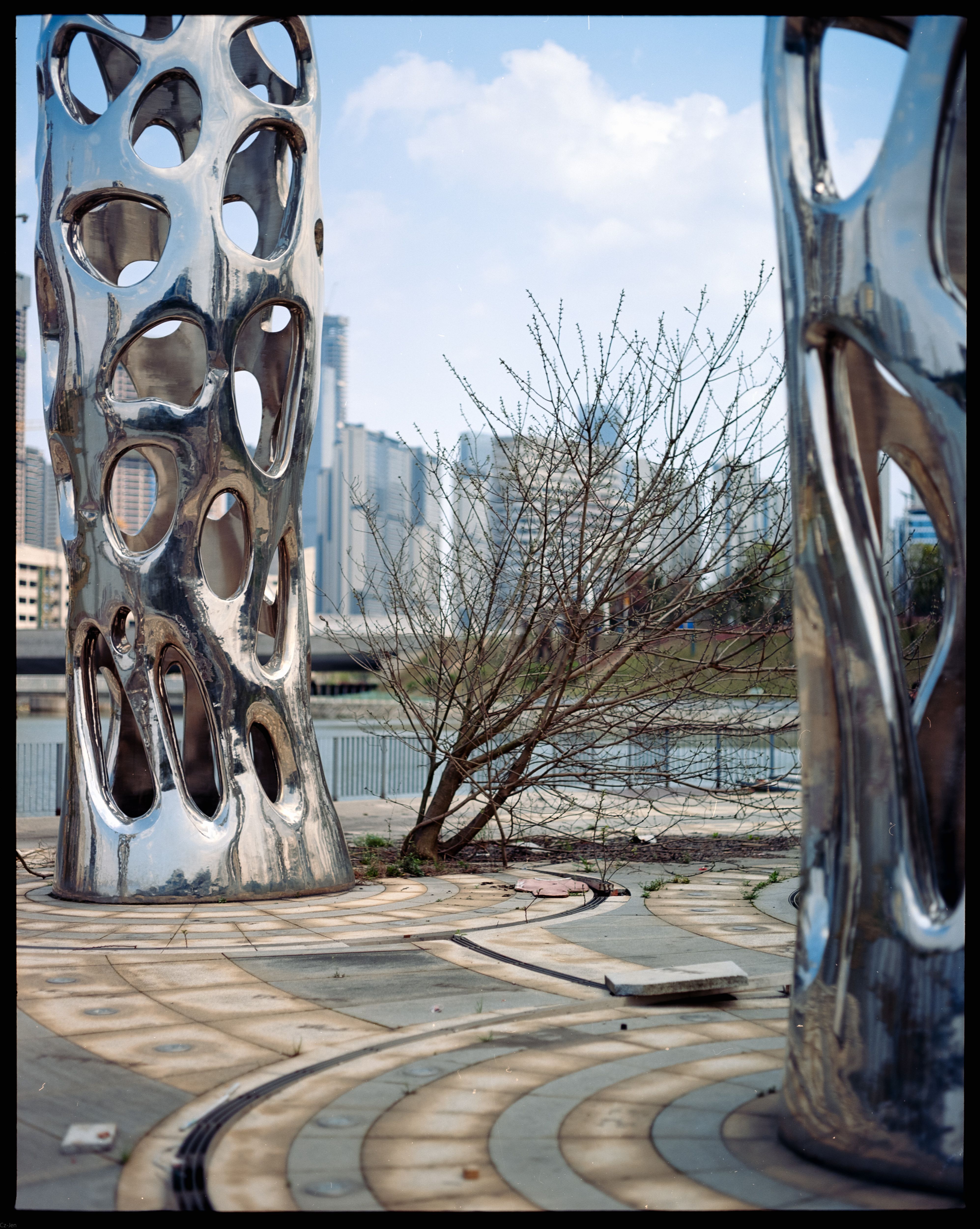 Two large metal sculptures in front of a river · Free Stock Photo