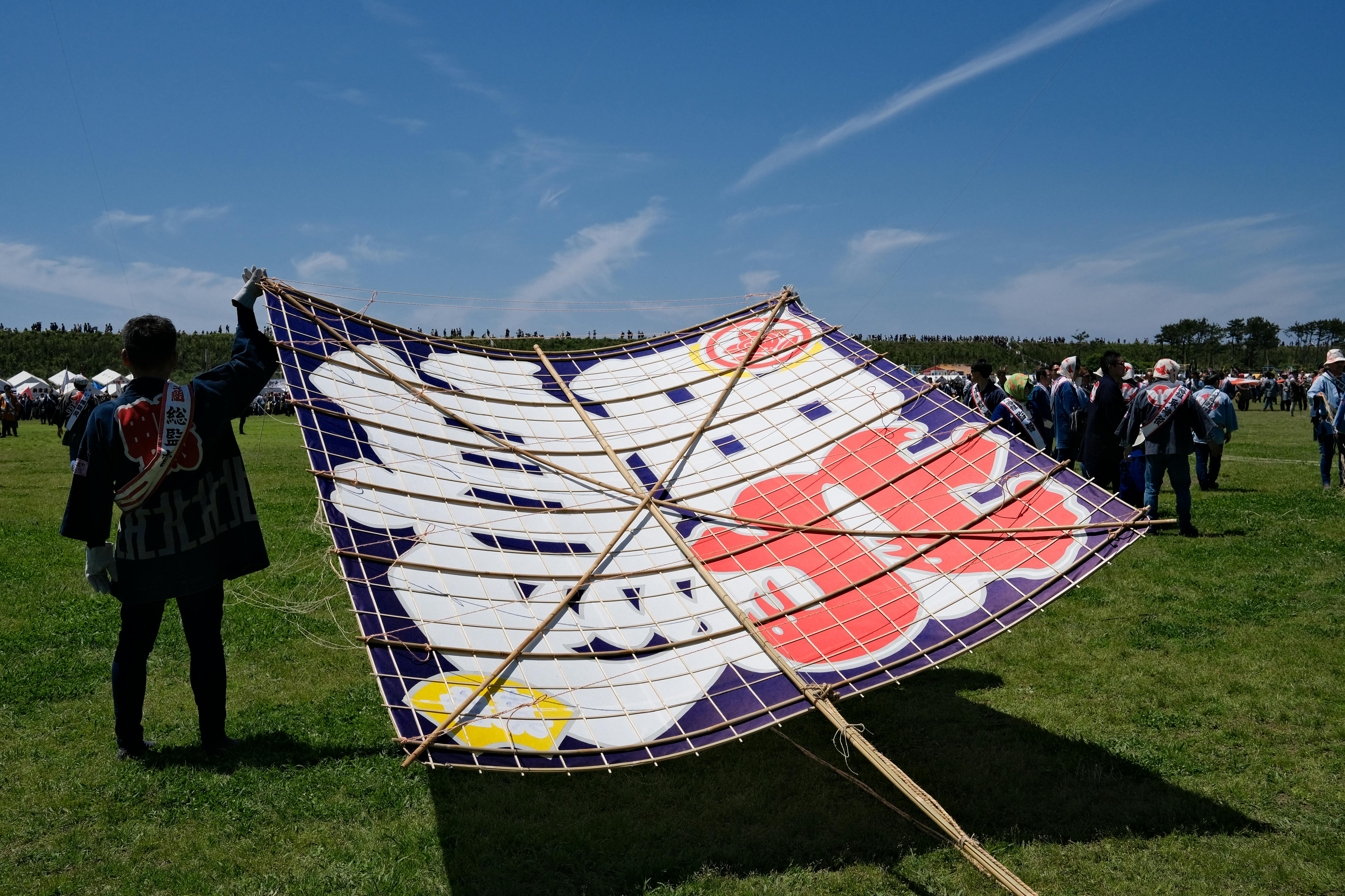 Men Holding Floating Giant Kite · Free Stock Photo