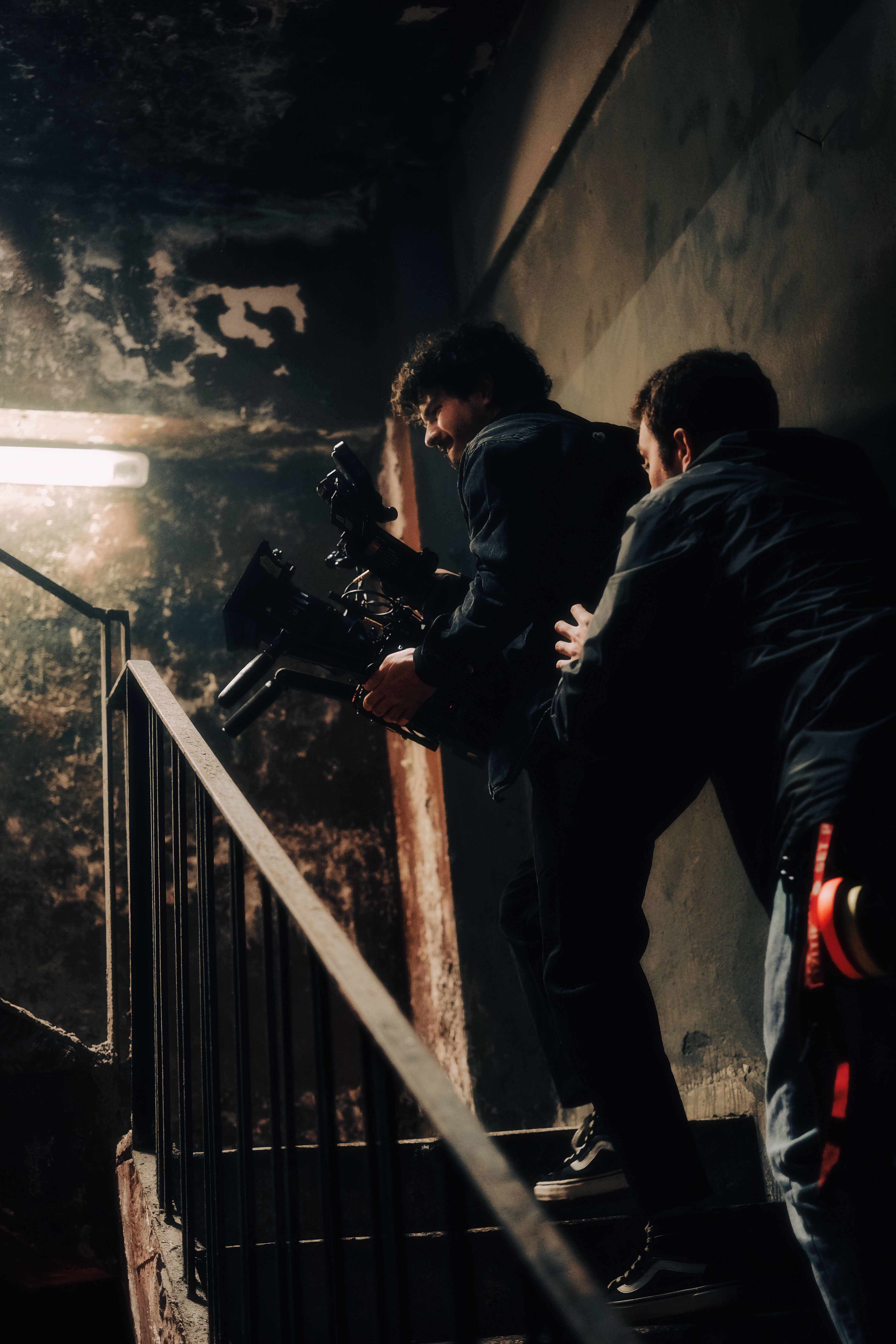 A Man Filming a Scene with a Professional Camera in an Abandoned ...
