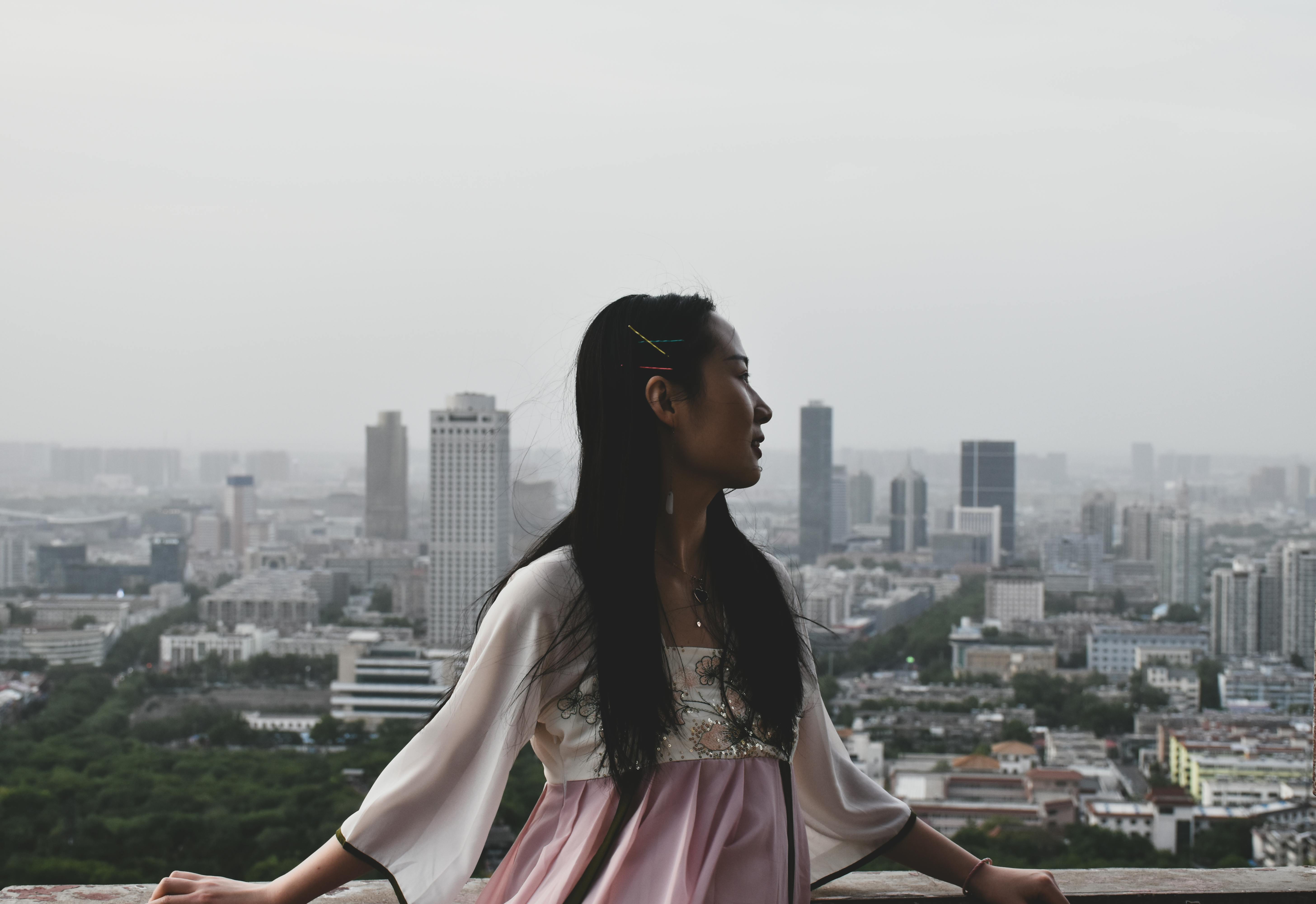 Woman Wearing White and Pink Dress Lean on Railings · Free Stock Photo