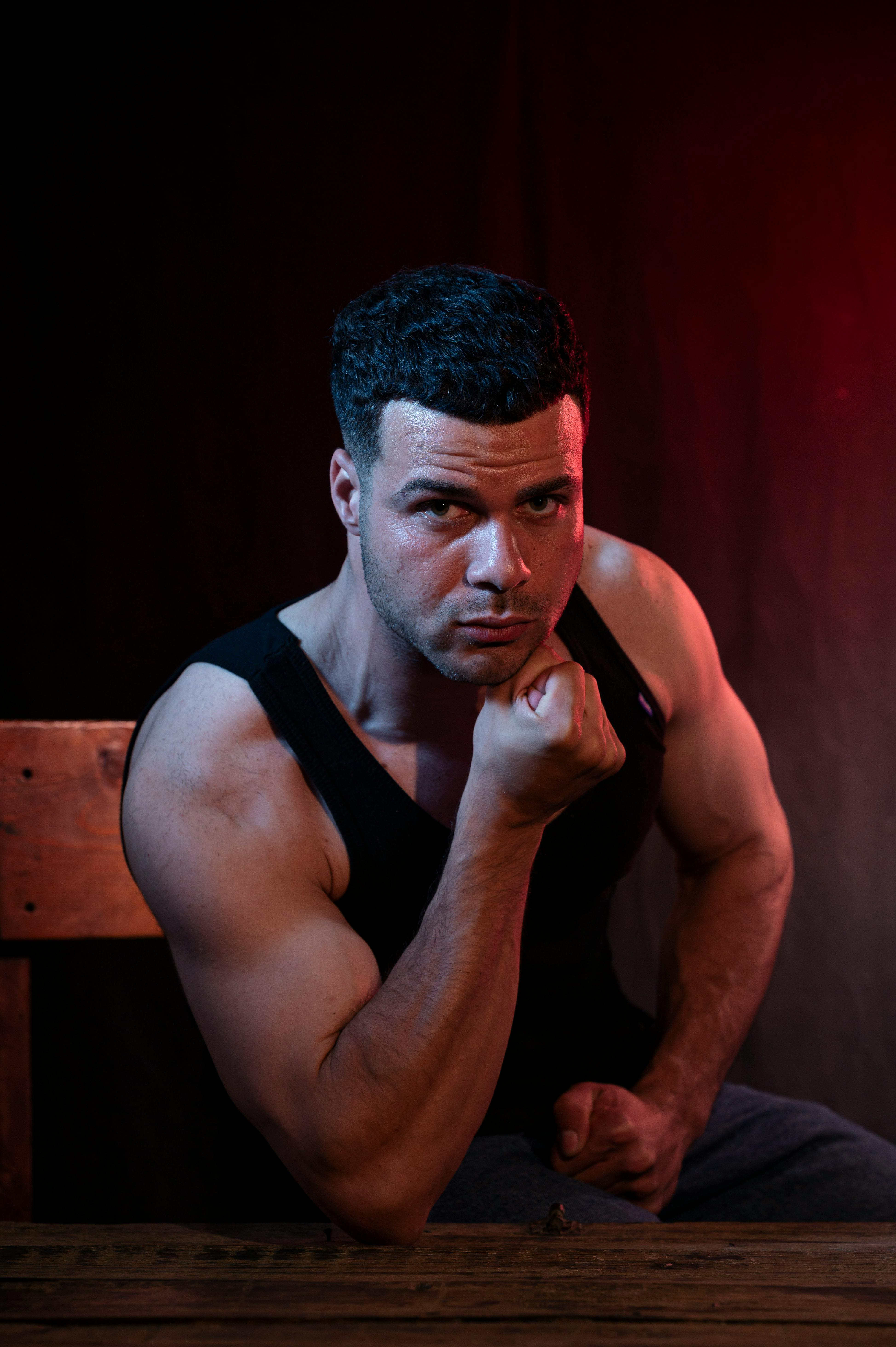 Muscular Brunette Flexing Muscles · Free Stock Photo