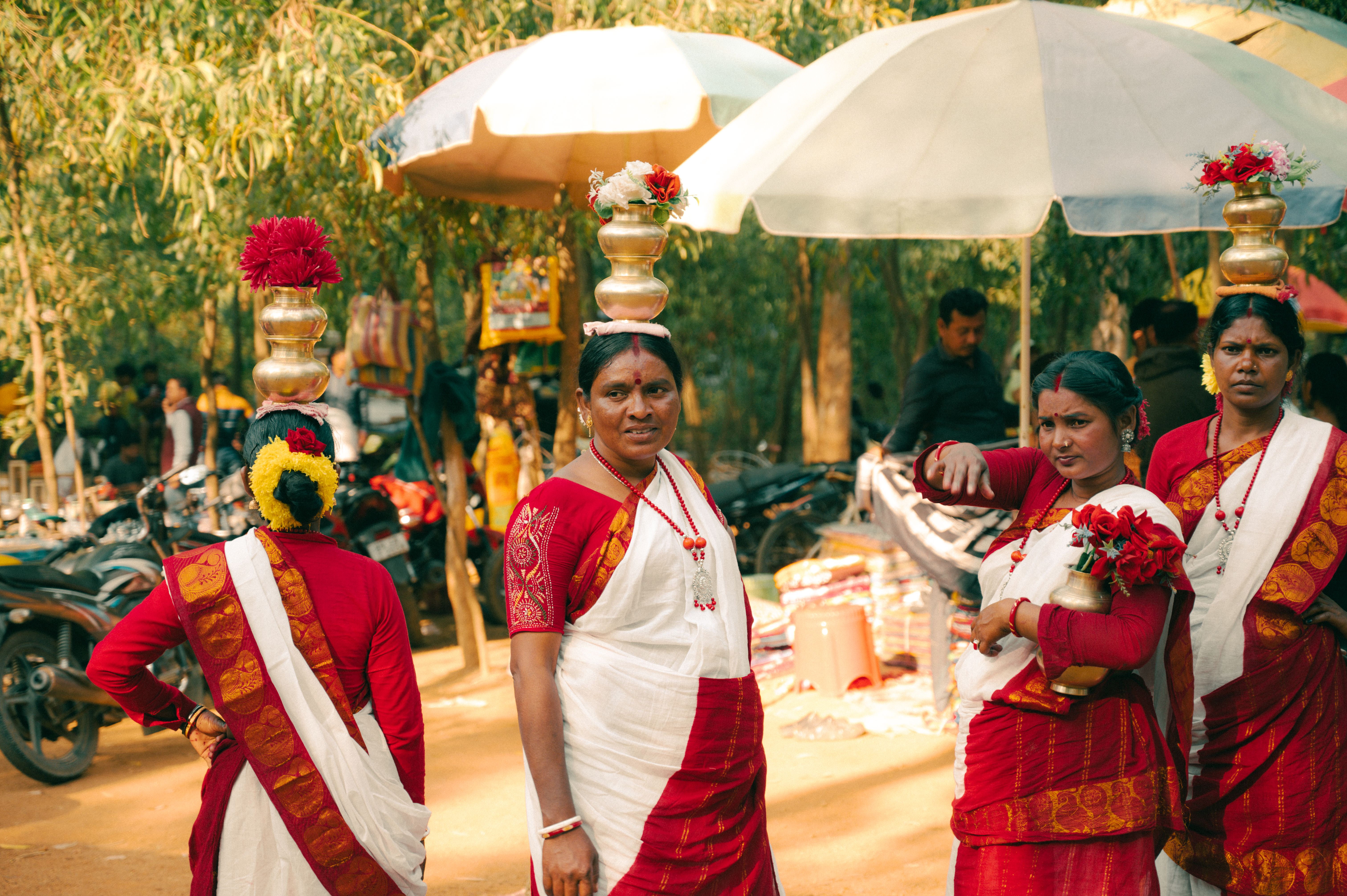 Women in Bengali Traditional Attire Carrying Vases with Flowers on ...