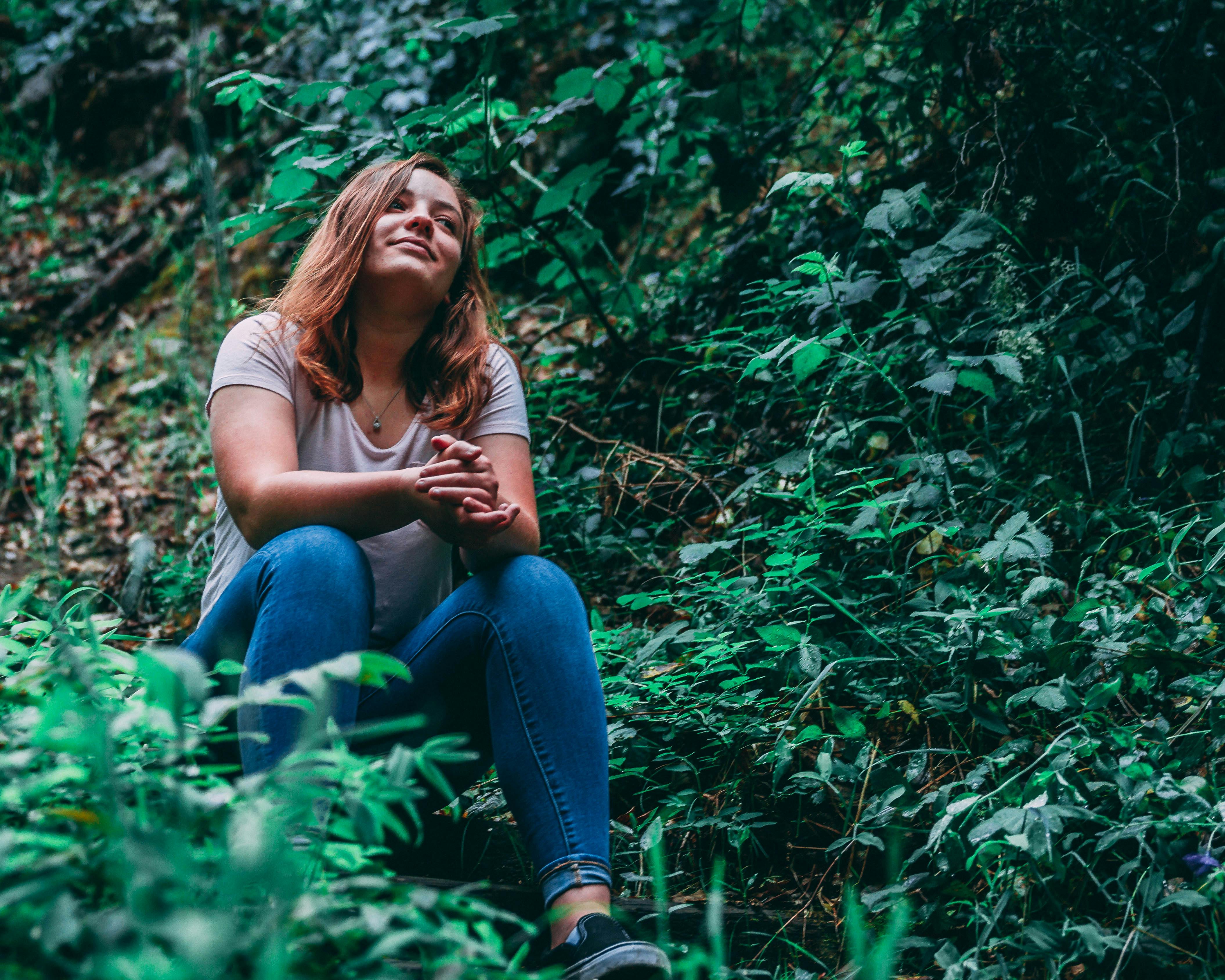 Woman Sitting On Ground Surrounded With Plants · Free Stock Photo