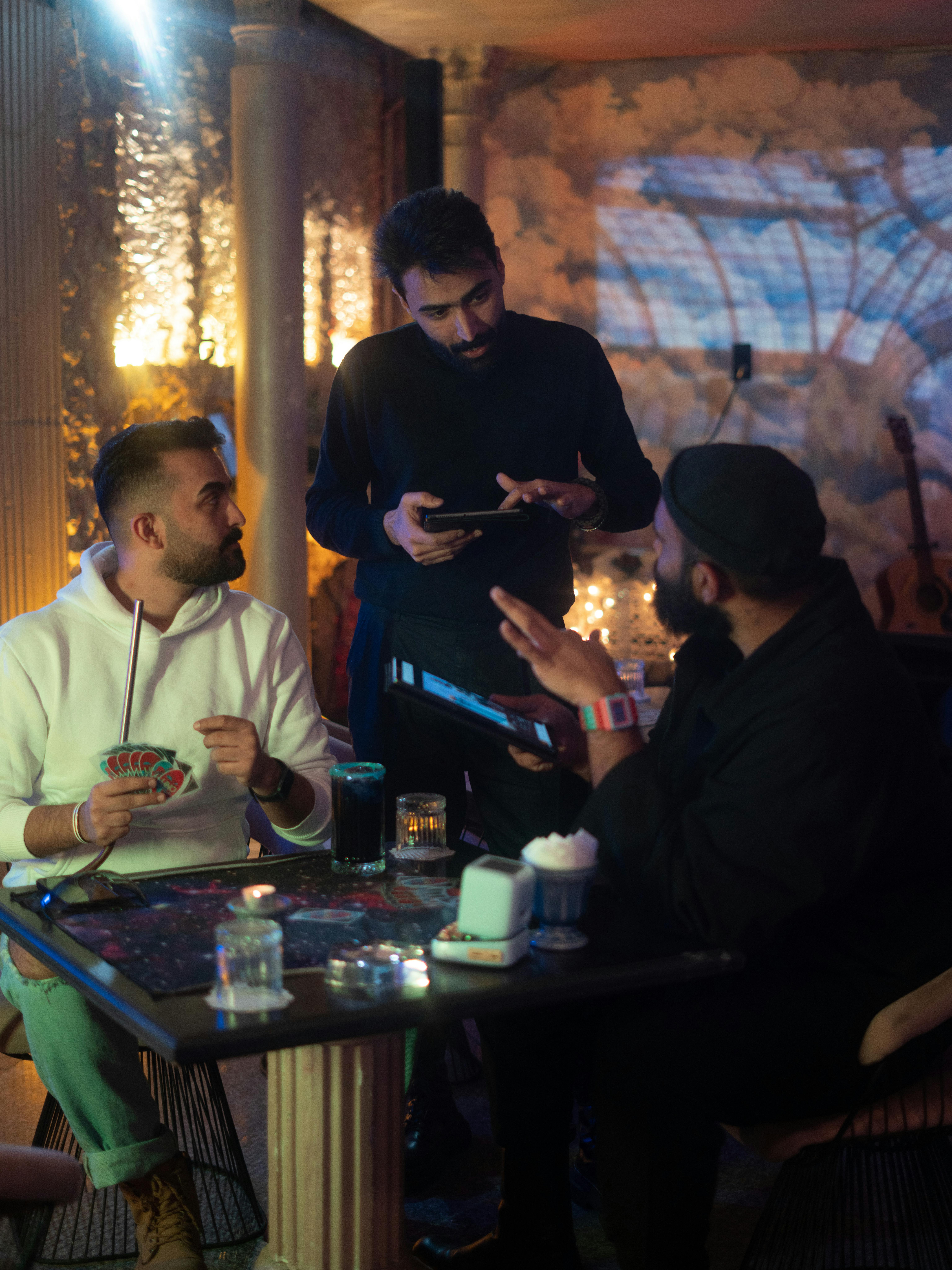 Waiter and Men at Restaurant · Free Stock Photo