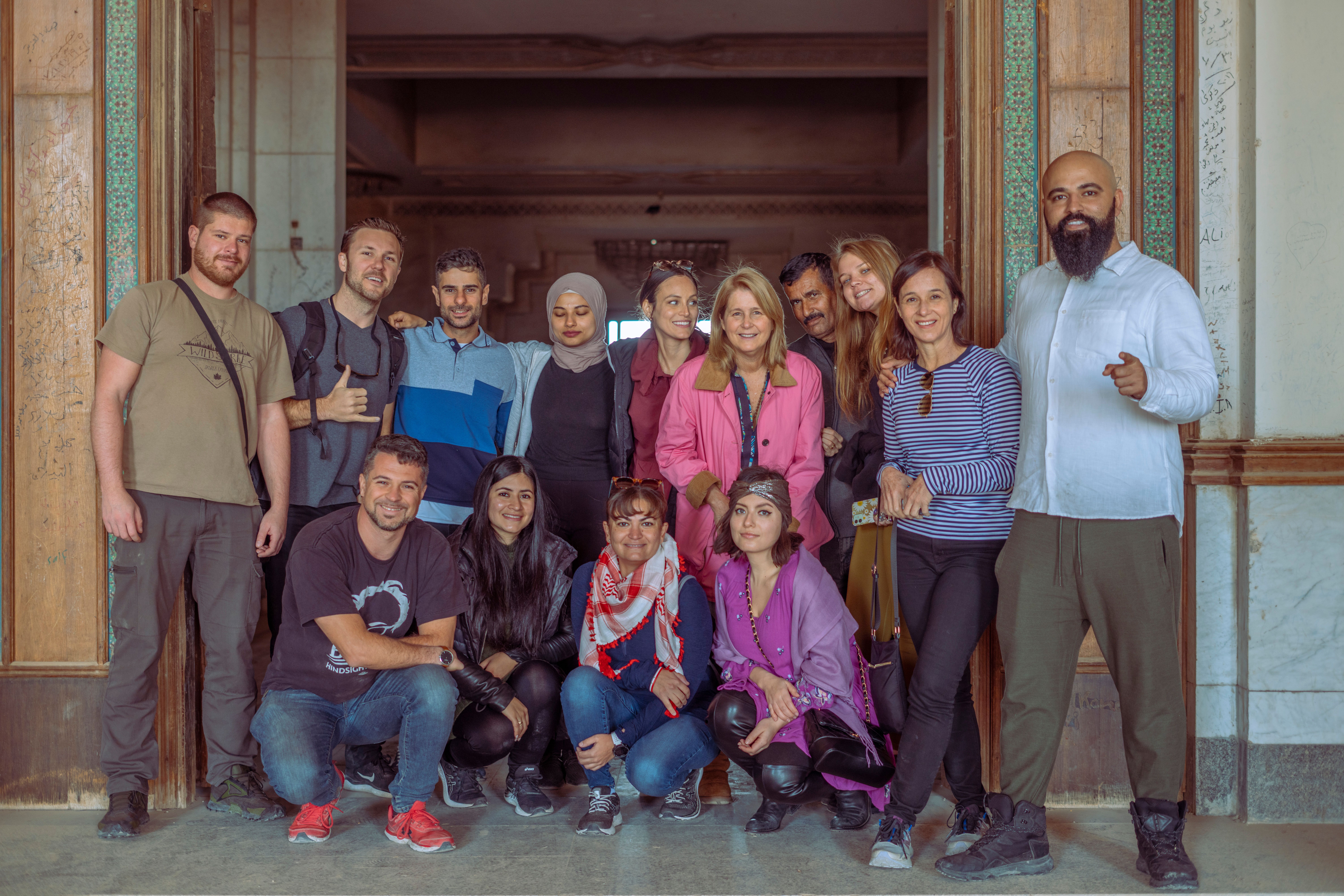 Group Portrait of Smiling Tourists Posing in Front of a Moorish Style ...