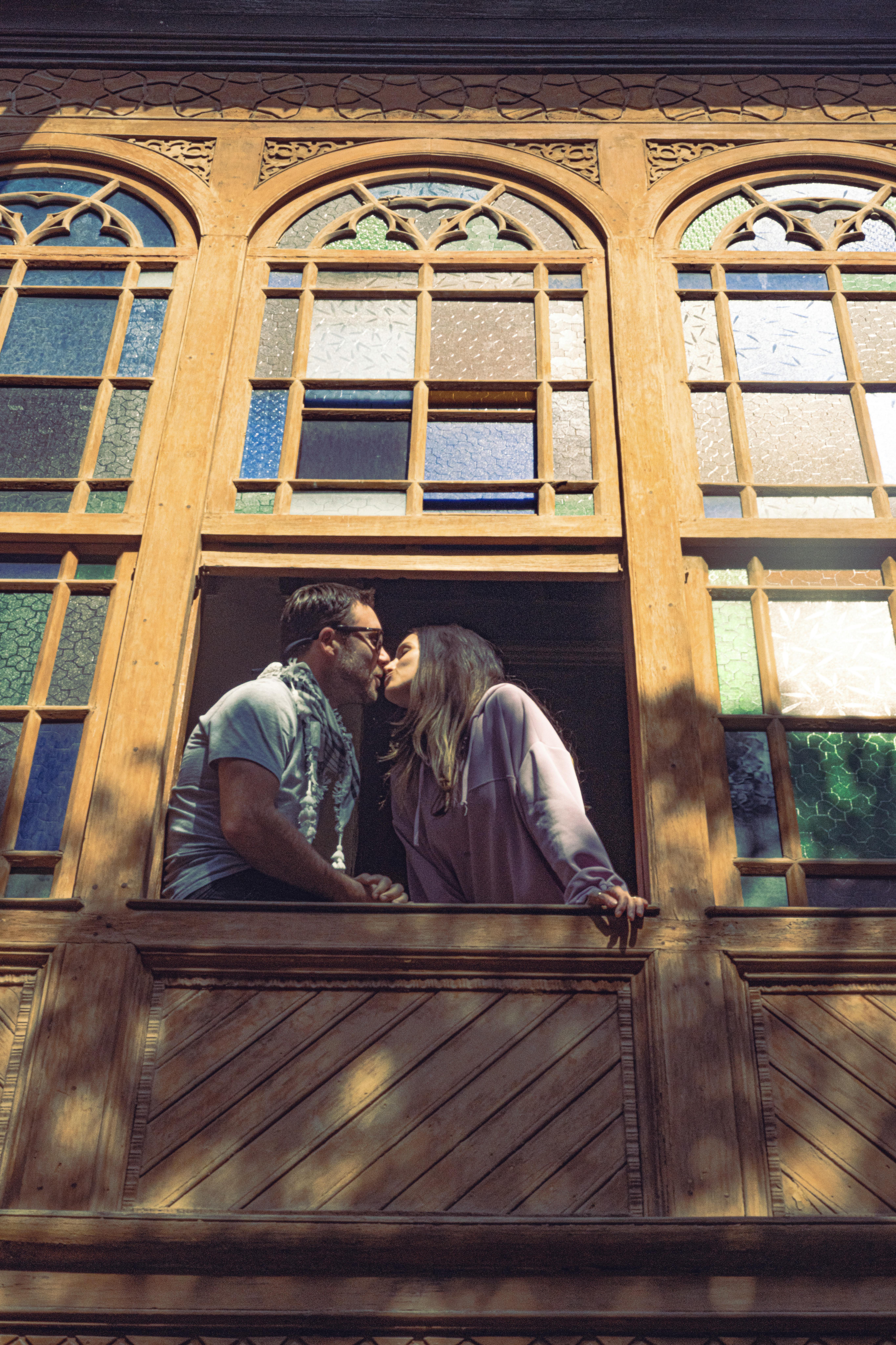 Kissing Couple in Window · Free Stock Photo