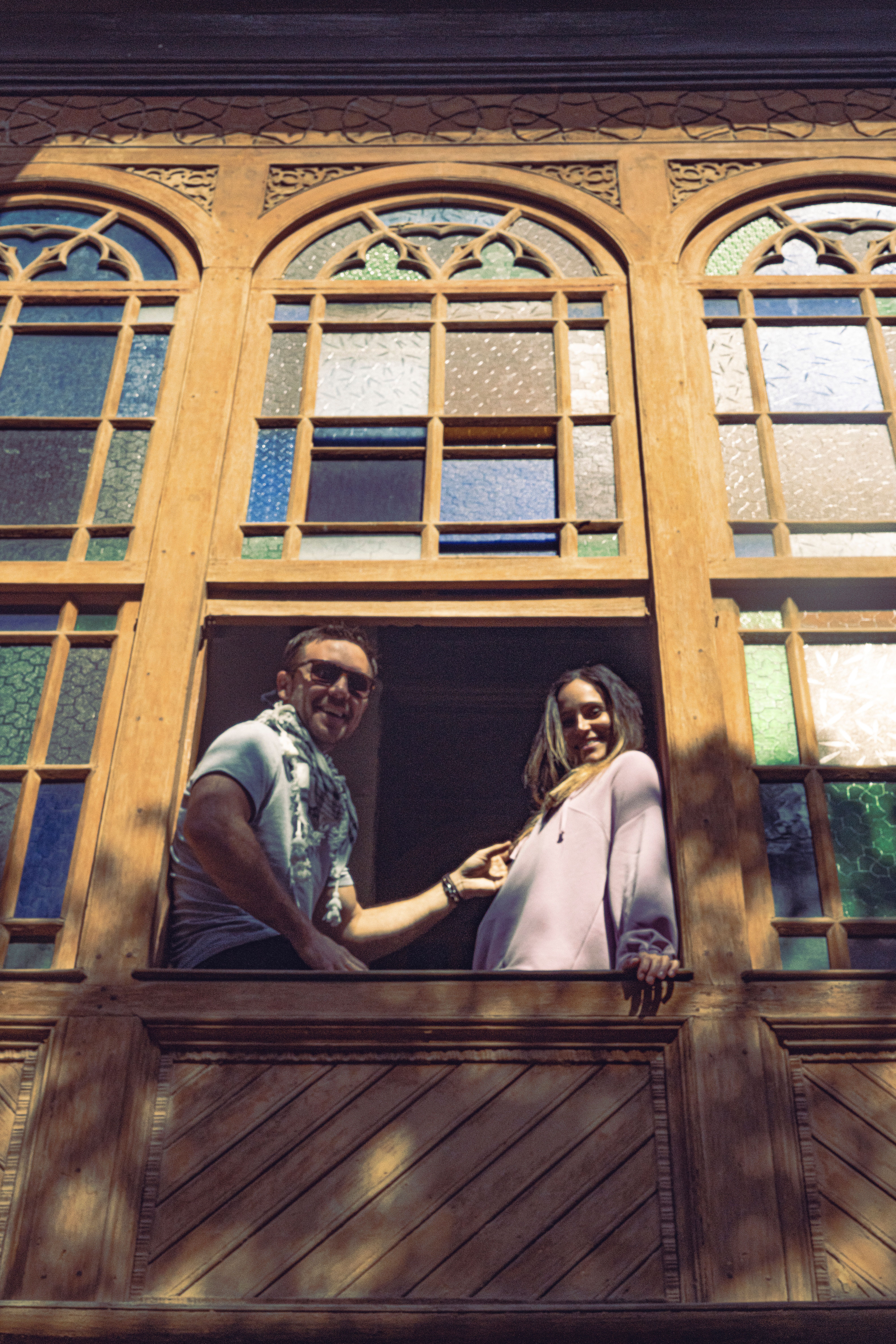 Smiling Couple in Window · Free Stock Photo