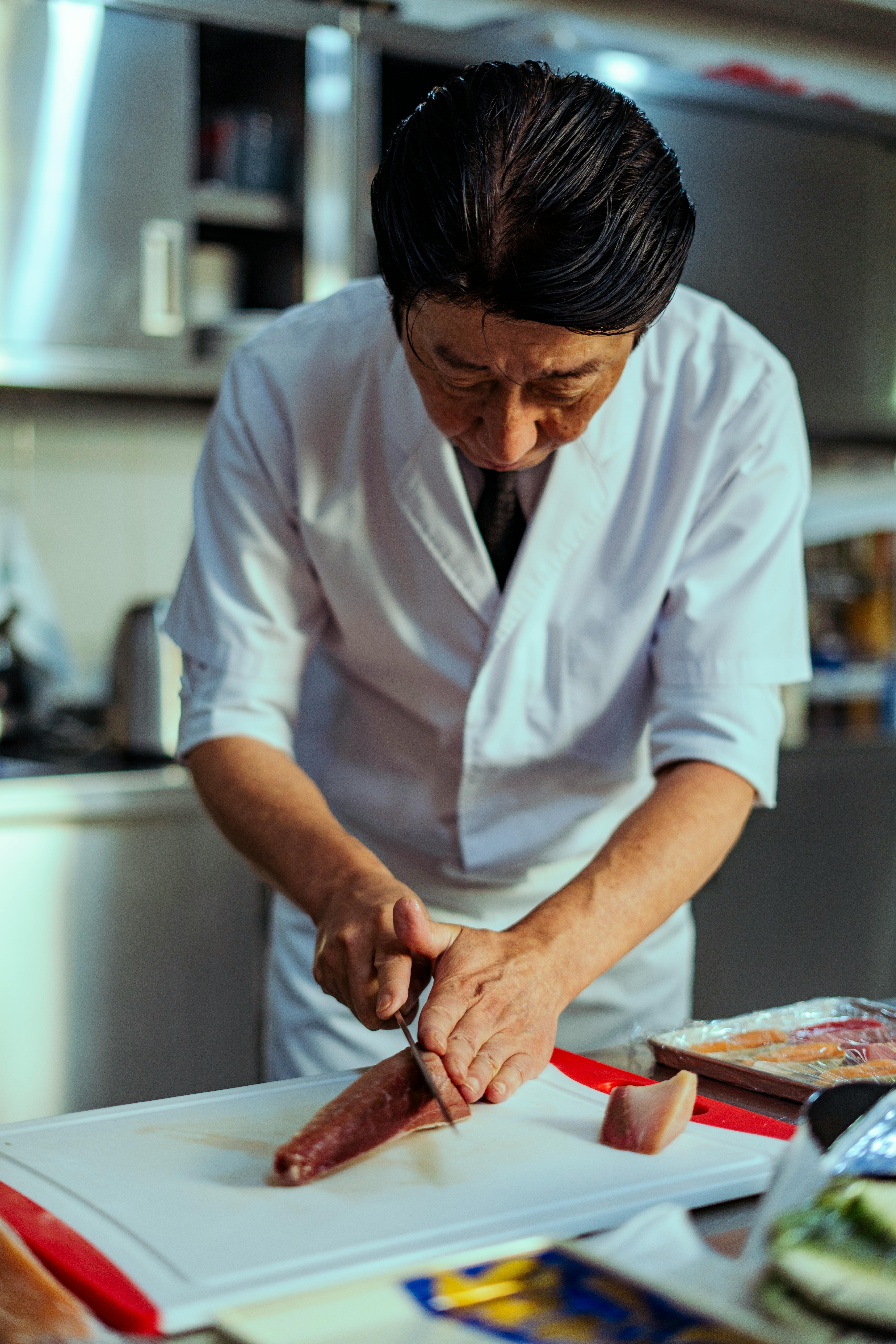 Cook Cutting Meat · Free Stock Photo